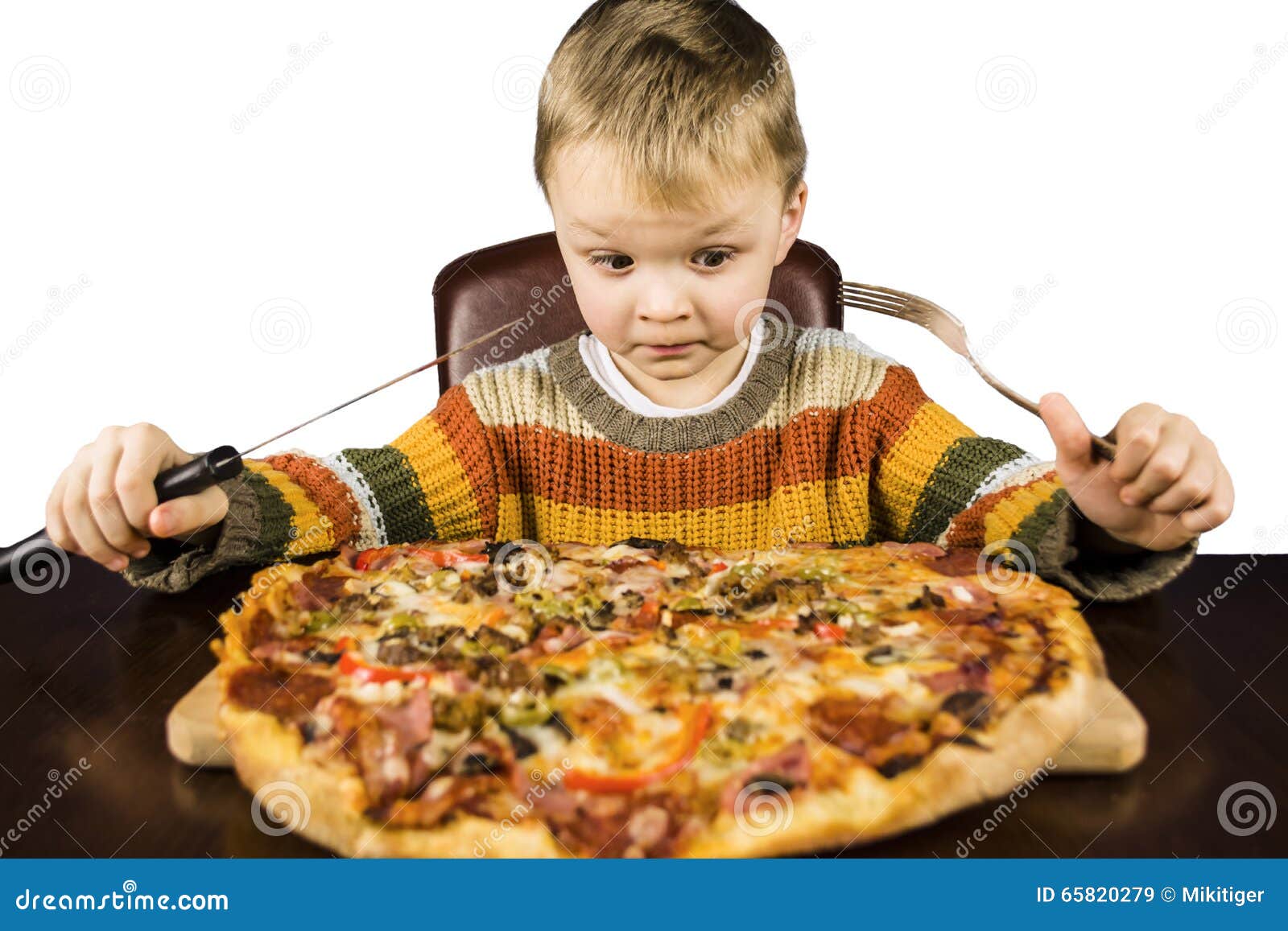 Boy eating pizza stock image. Image of large, table, knife - 65820279