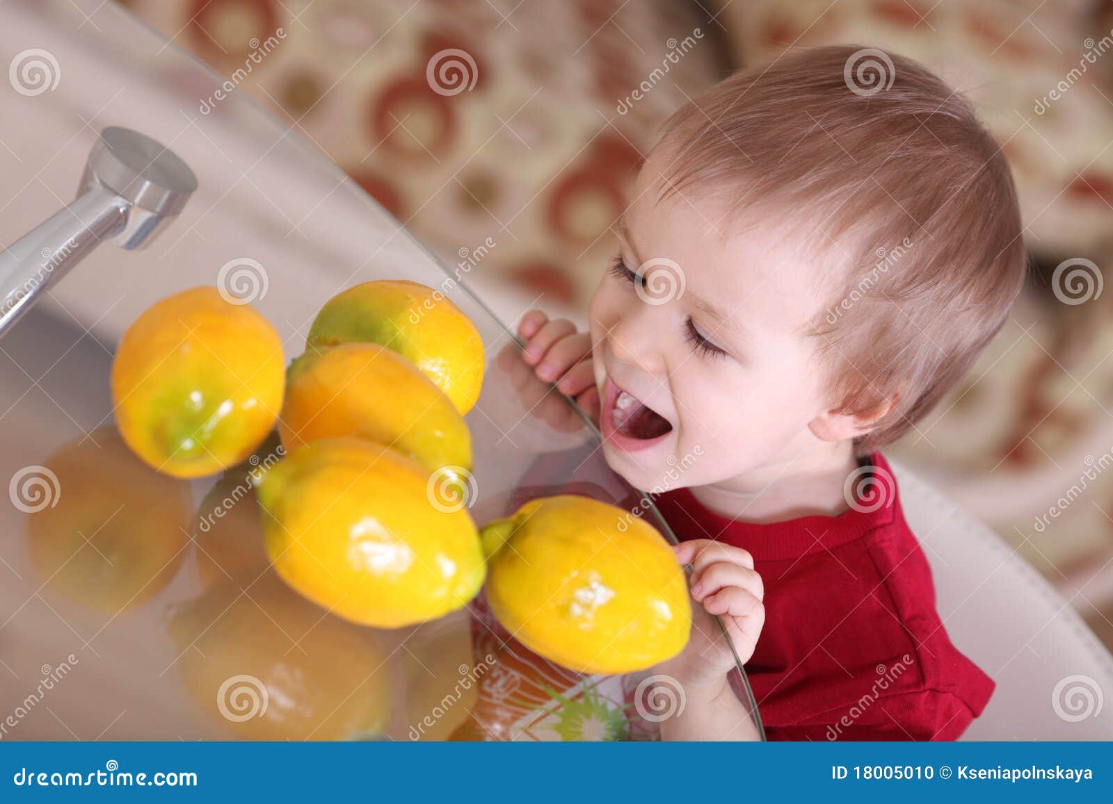 Boy Eating and Playing with Lemons Stock Photo - Image of hair, mouth ...