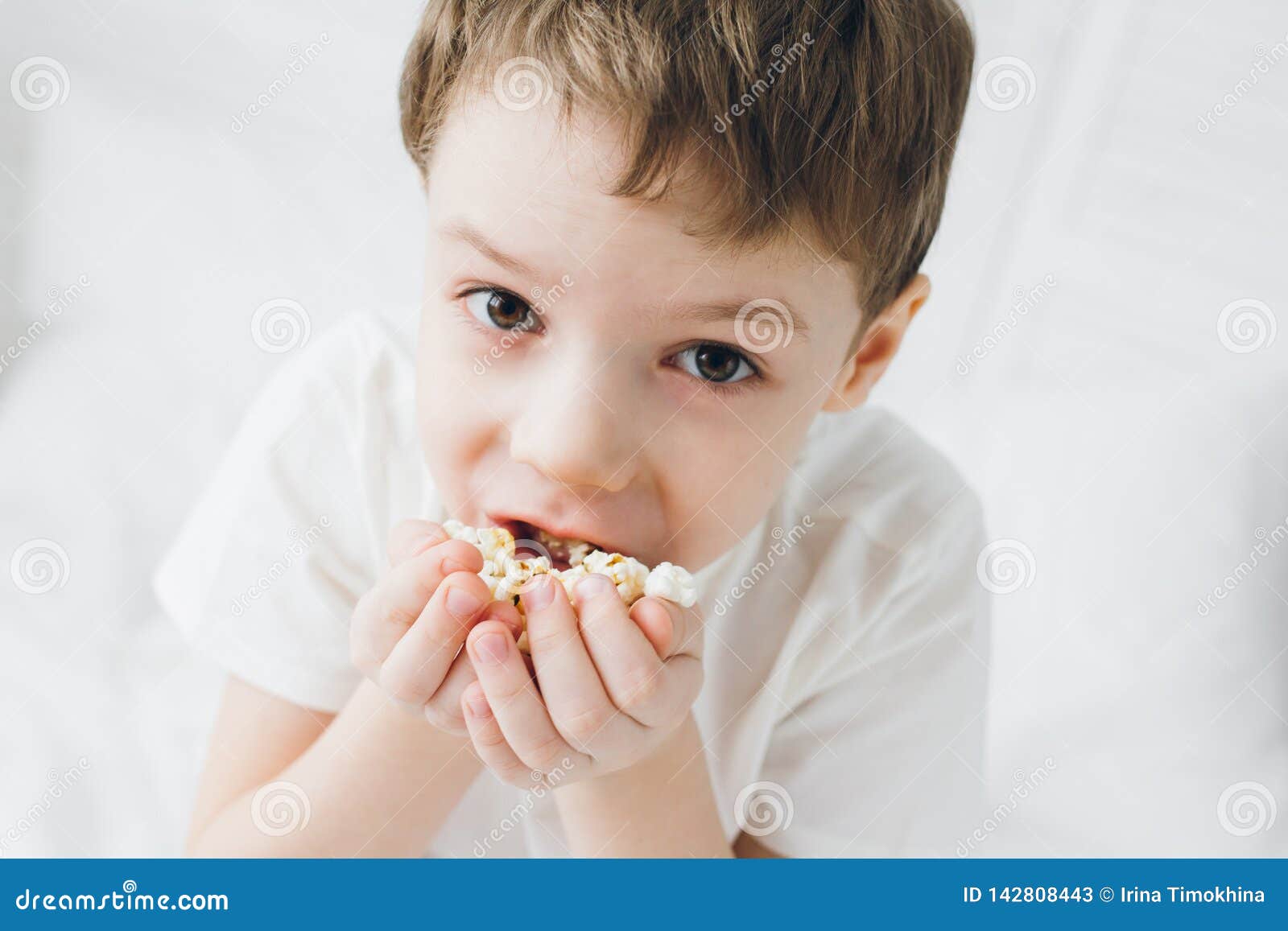 Boy Eating Popcorn Sitting in Bed Stock Image - Image of person, remote ...