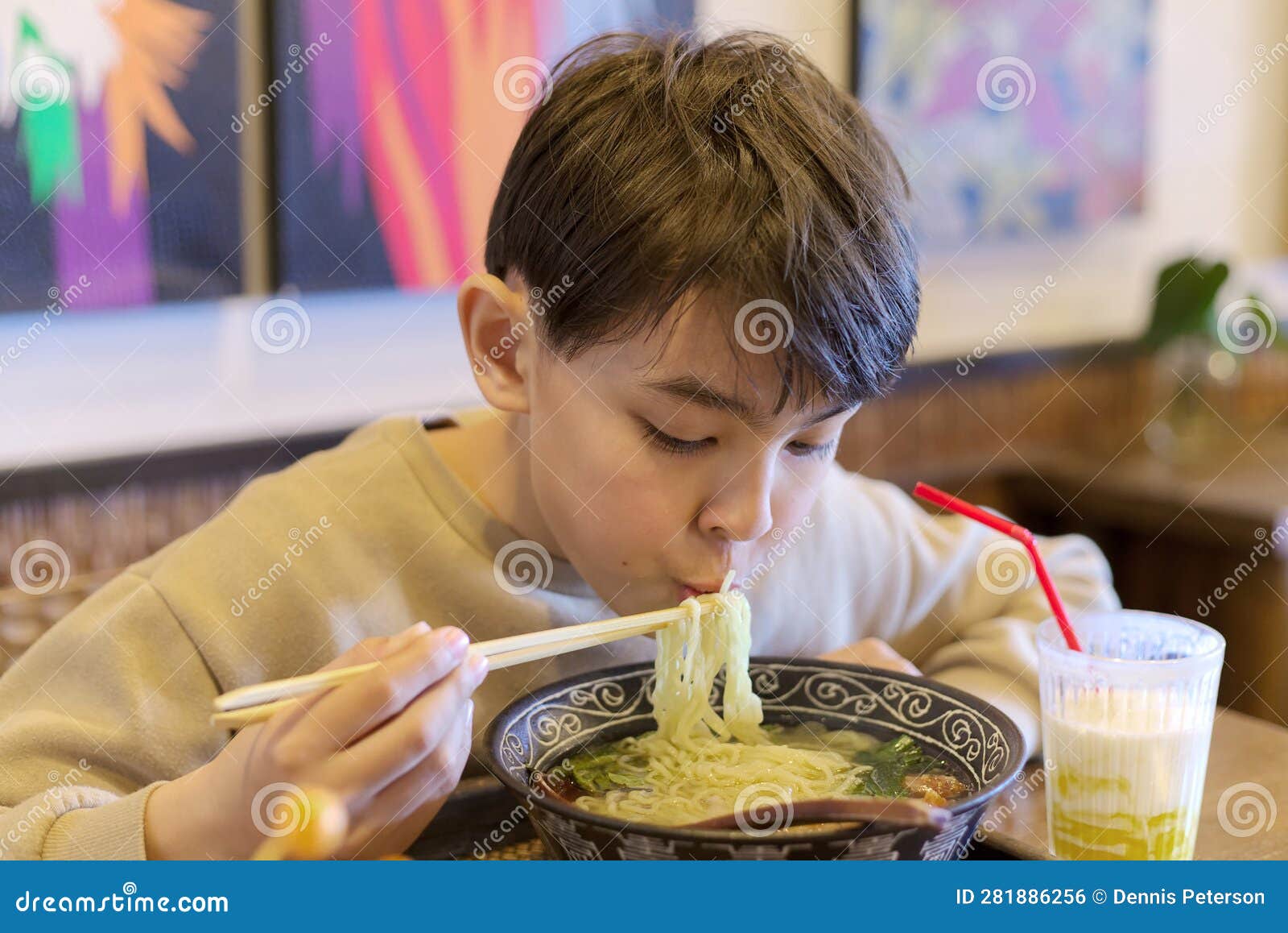 A boy eating ramen noodles stock photo. Image of japan - 281886256