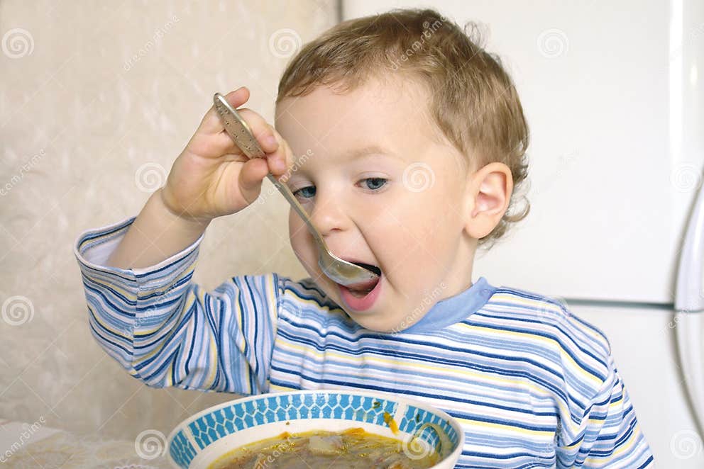 Boy eating soup stock photo. Image of kitchen, blue, male - 3496168