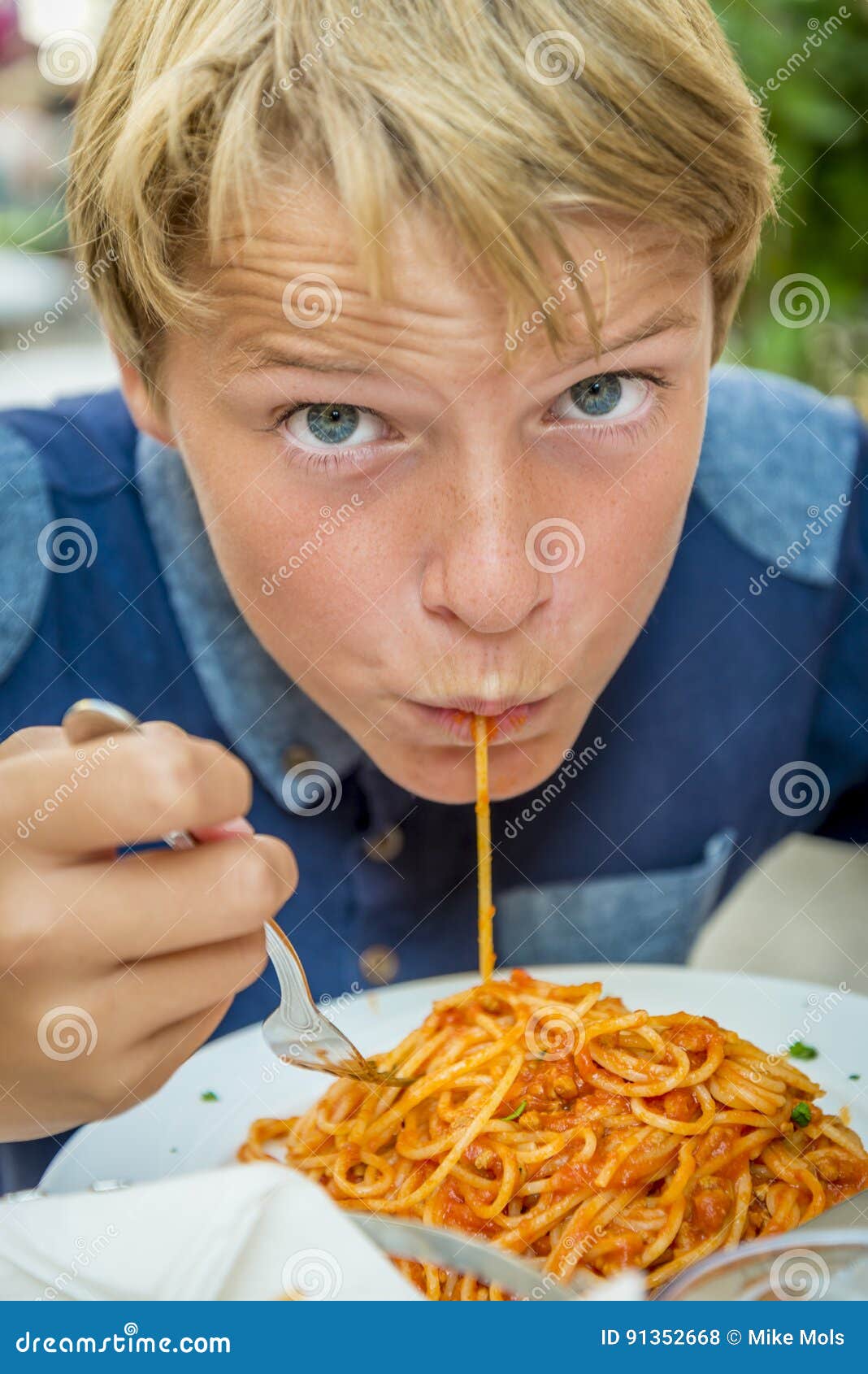 Boy eating spaghetti stock photo. Image of eyes, bolognese - 91352668