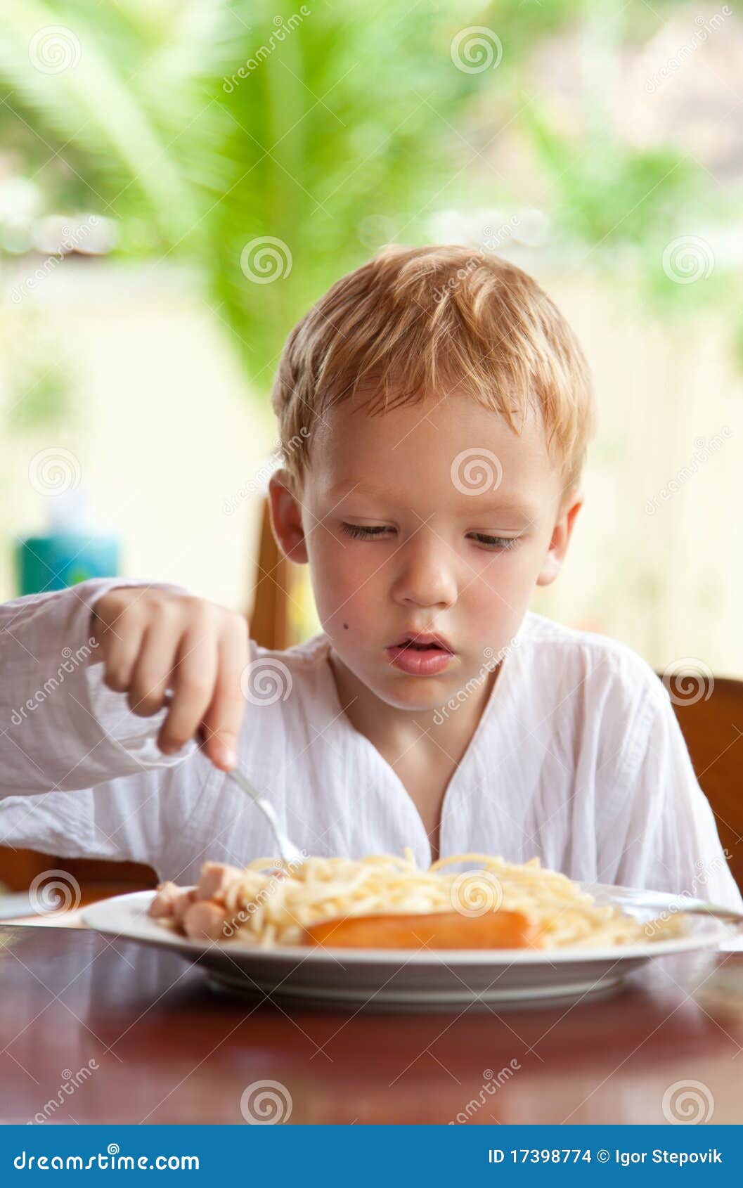 Boy Eating Spaghetti with Sausages Outdoors Stock Photo - Image of ...