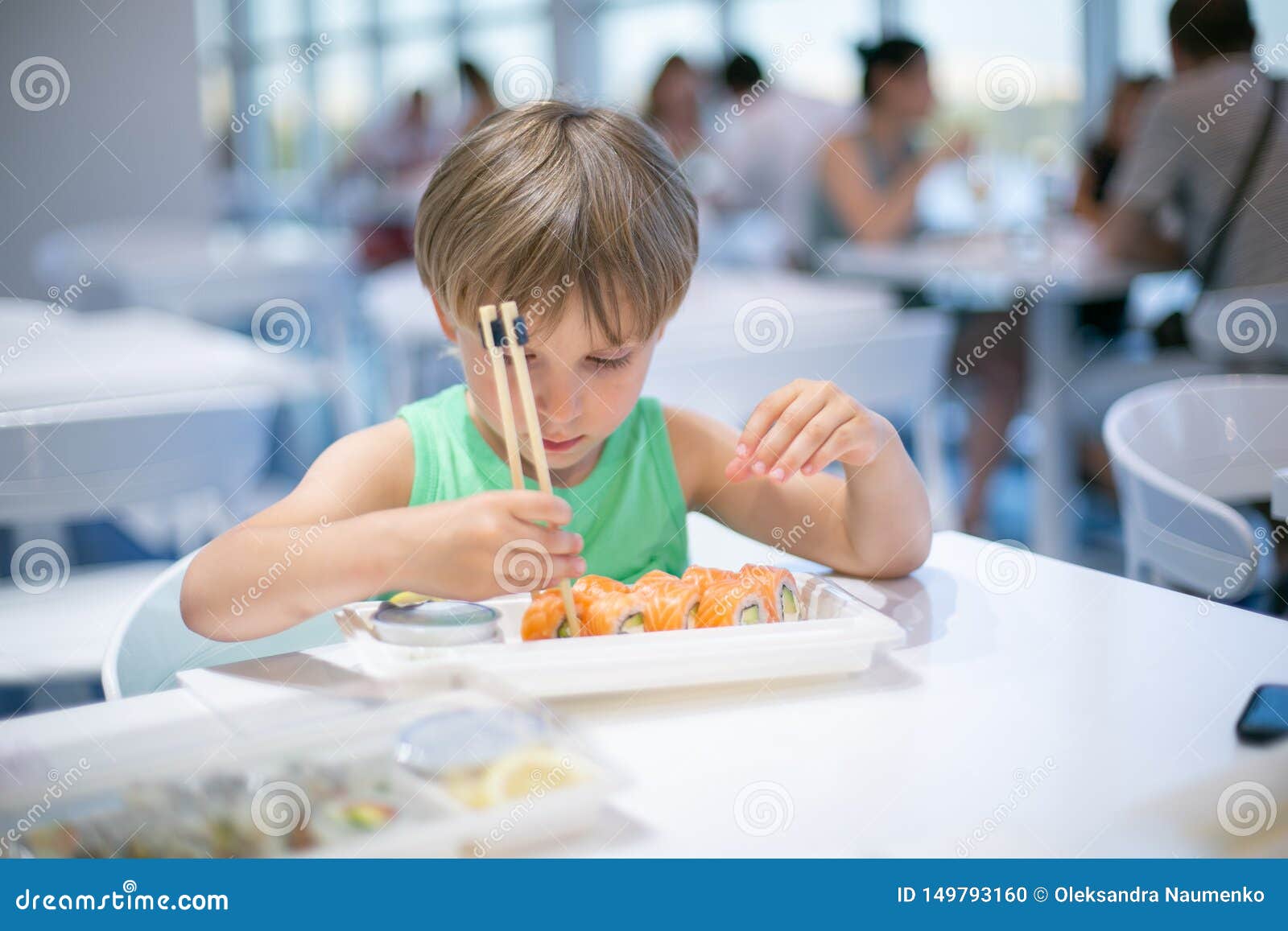 Boy Eating Sushi in a Reataurant Stock Photo - Image of white, young ...