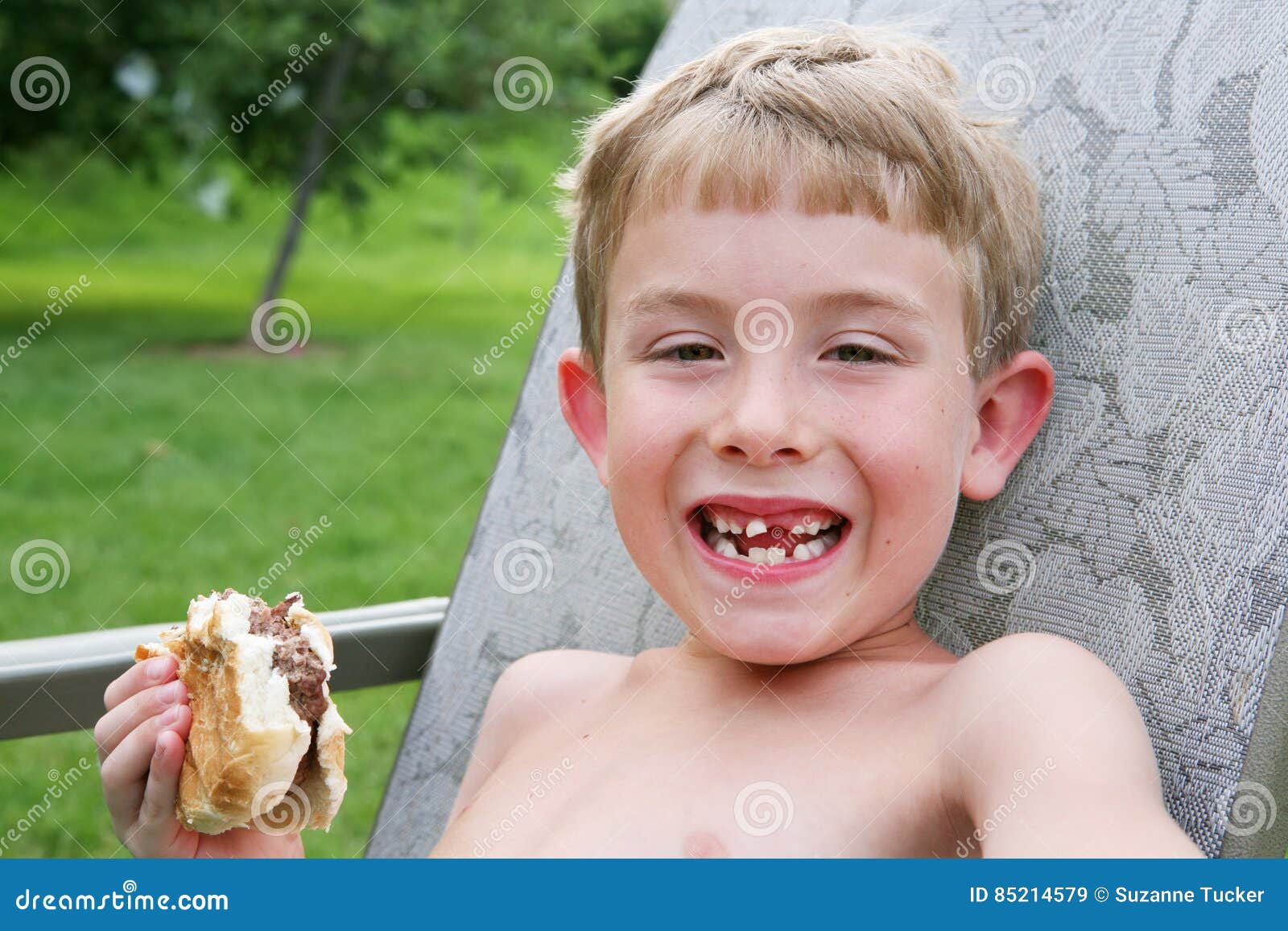 Boy Eating with a Very Loose Front Tooth Stock Image - Image of holding ...