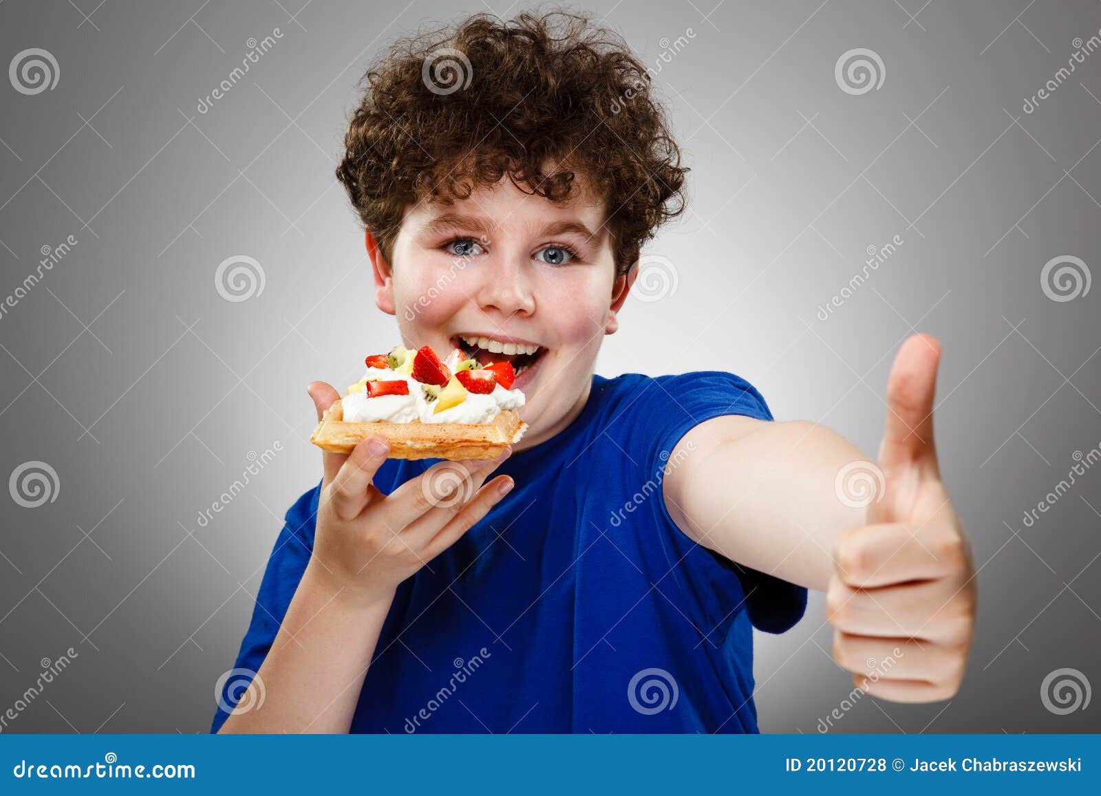 Boy eating waffle stock photo. Image of showing, fruits - 20120728