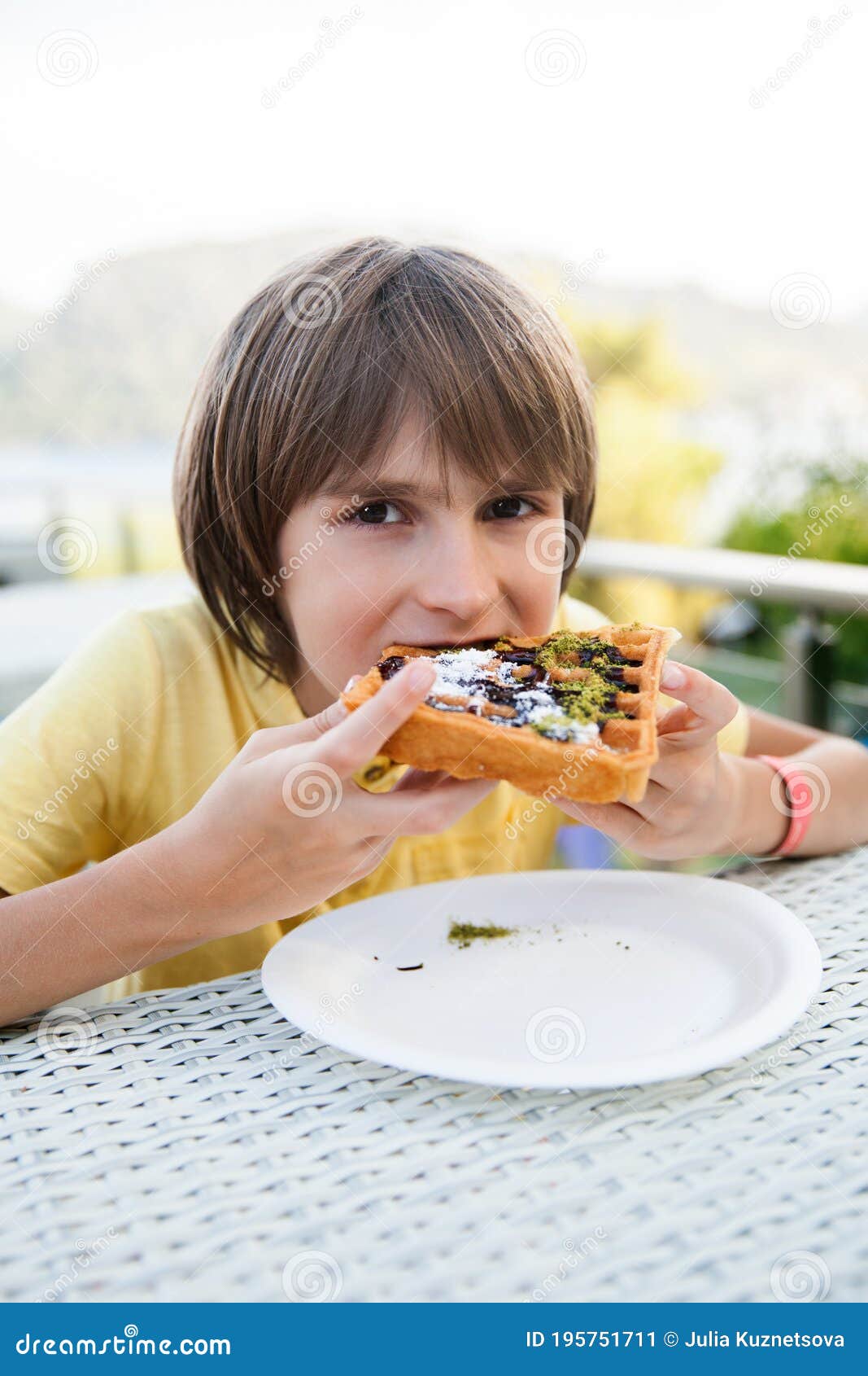 A Boy is Eating Waffles in a Street Cafe Stock Image - Image of ...