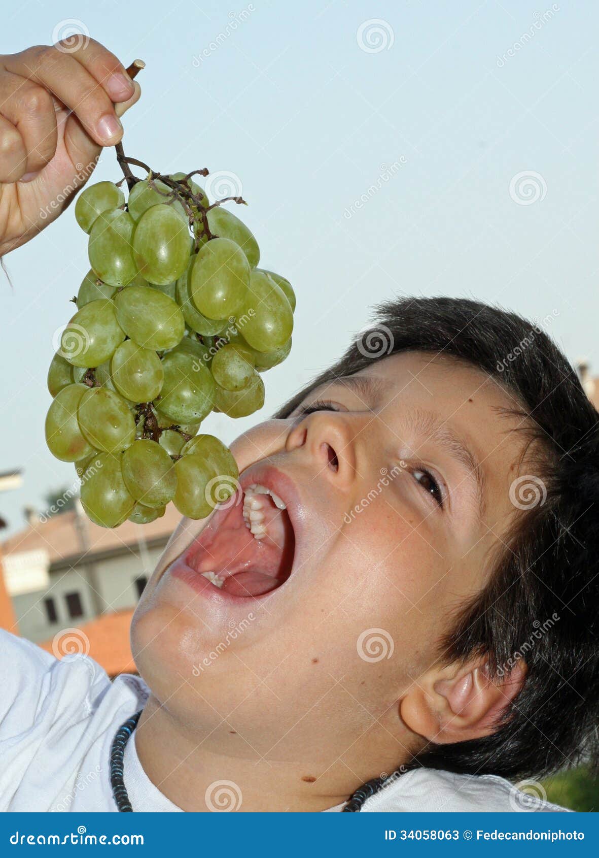 Boy eating white grapes stock image. Image of hand, cute - 34058063