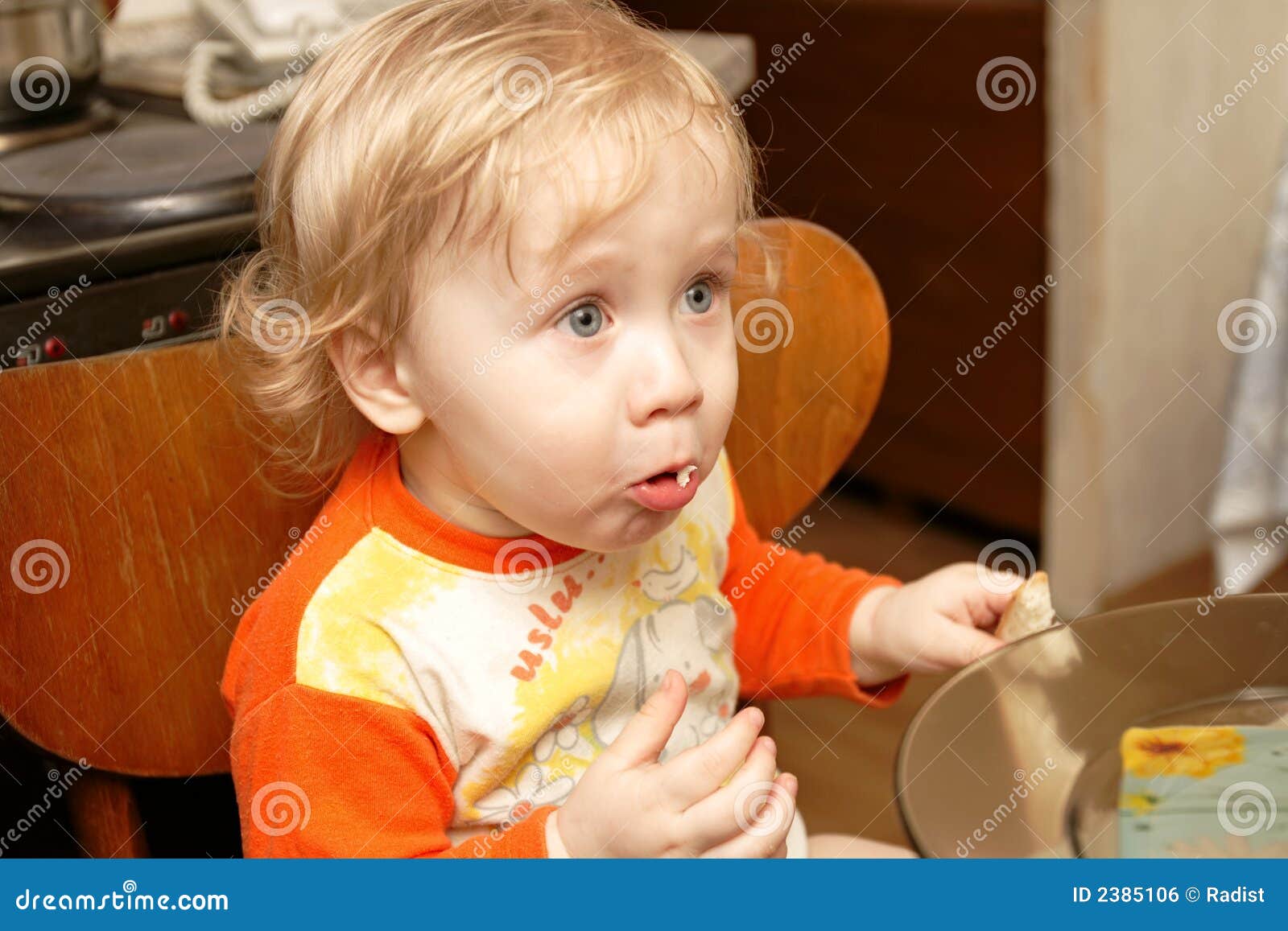 The boy eats bread stock photo. Image of preschooler, preschool - 2385106