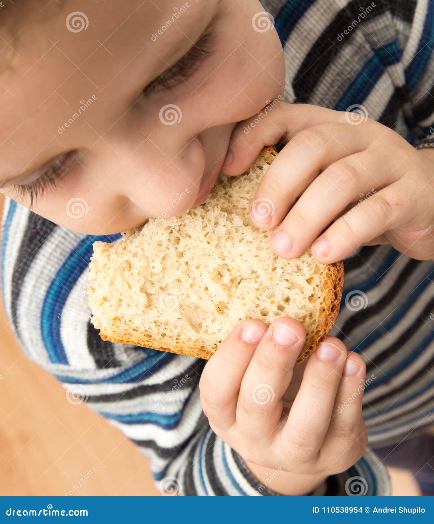 Boy eats bread stock photo. Image of face, white, smiling - 110538954