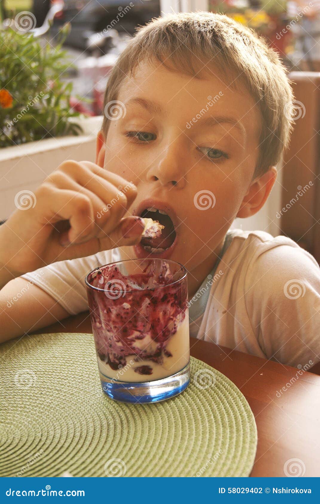 Boy eats from the glass stock photo. Image of colorful - 58029402