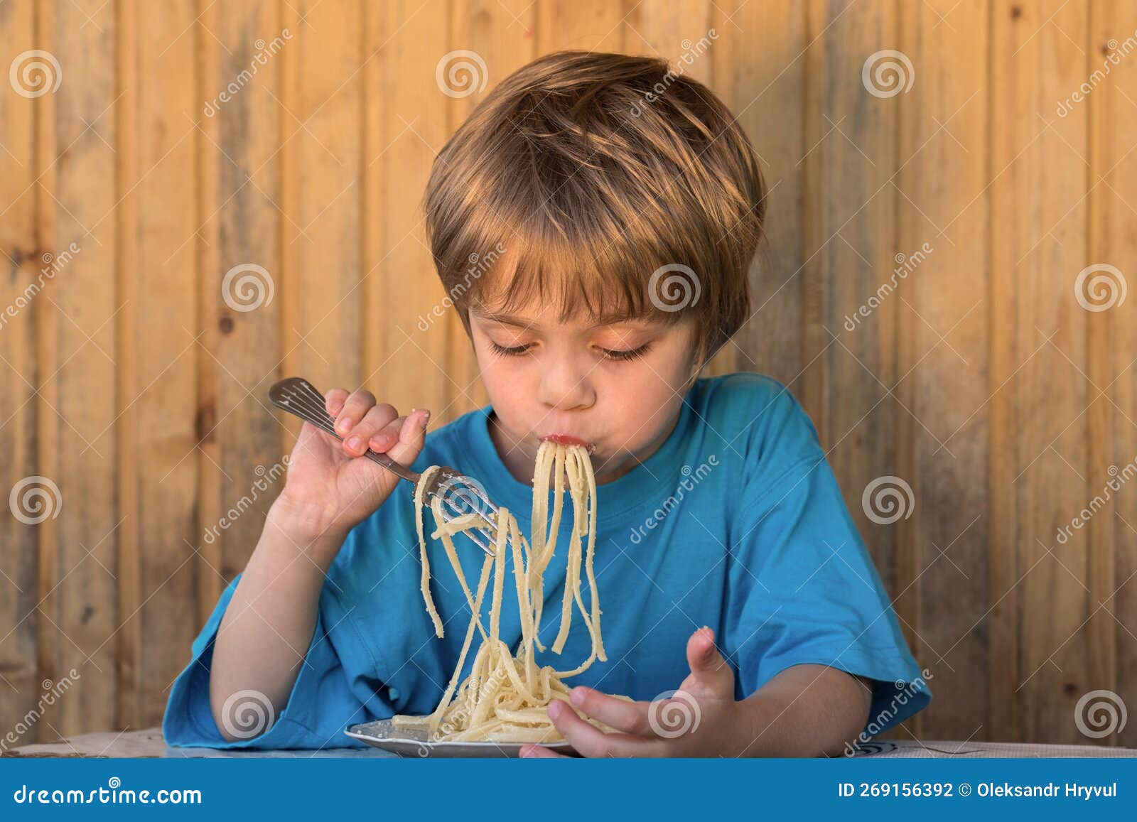 A Boy Eats Spaghetti with Parmesan Cheese Stock Photo - Image of ...