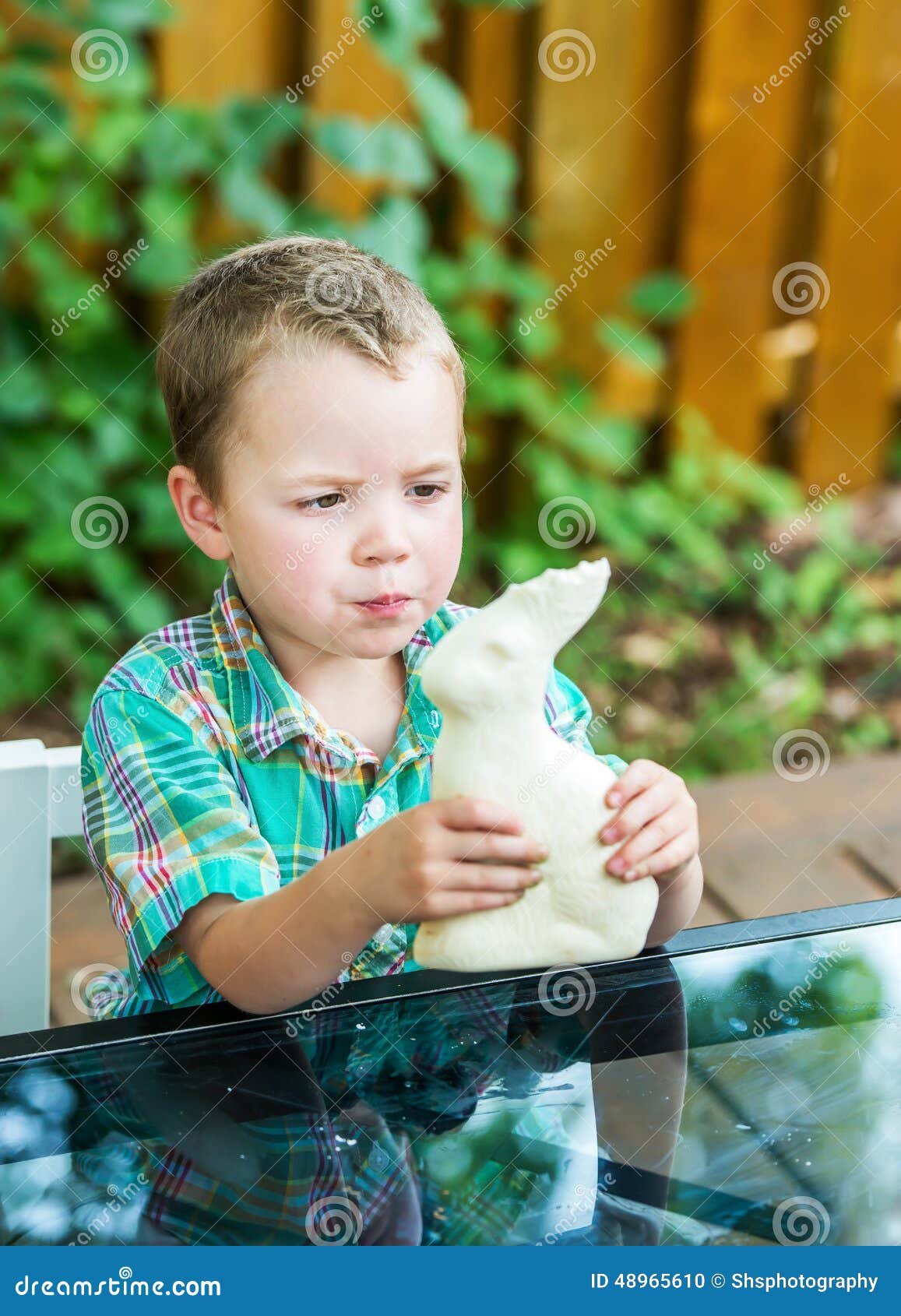 Boy Eats a White Chocolate Bunny Stock Photo - Image of outdoor, mouth ...