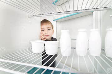 Boy and Empty Refrigerator stock photo. Image of bottles - 18362592