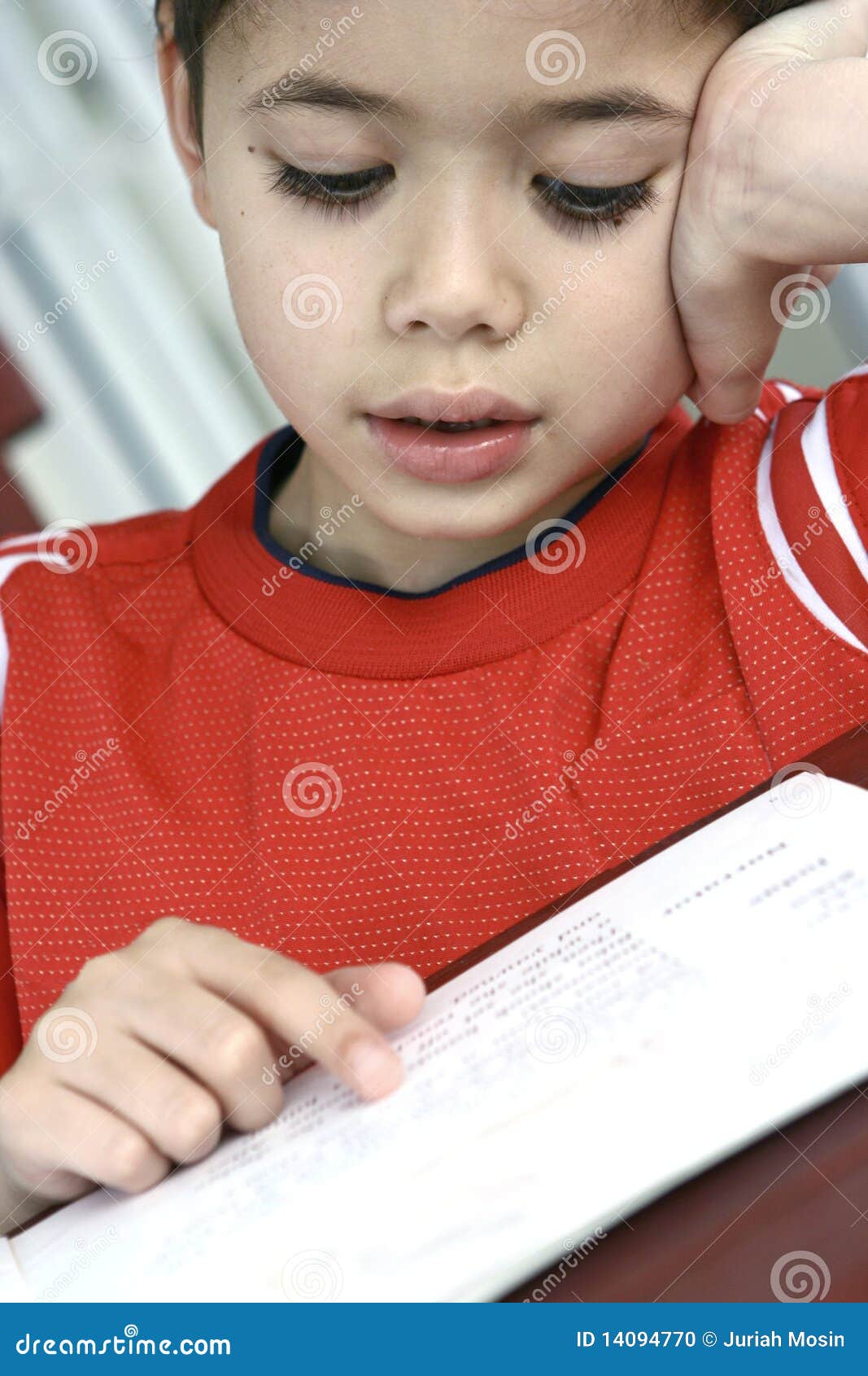 Boy Engrossed while Reading a Book. Stock Photo - Image of light ...