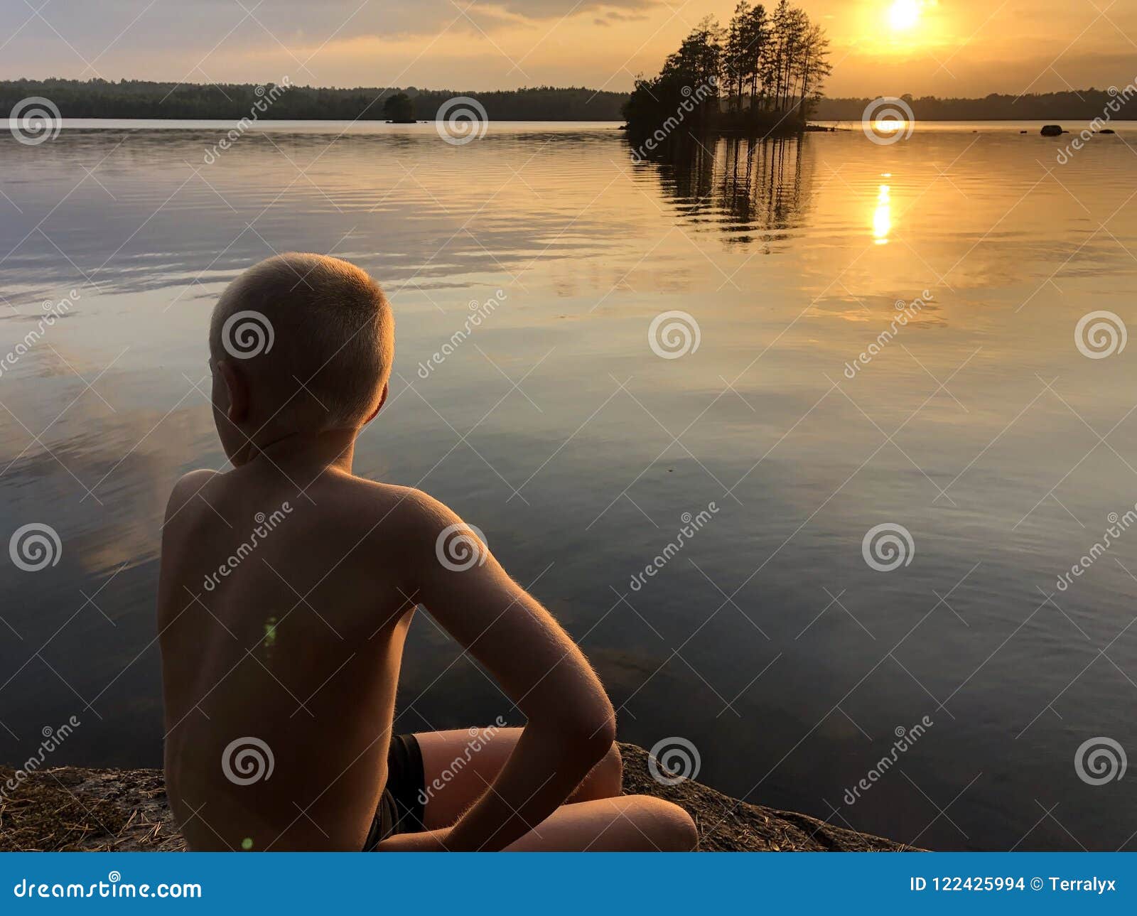 Boy enjoying the sunset stock photo. Image of tranquility - 122425994