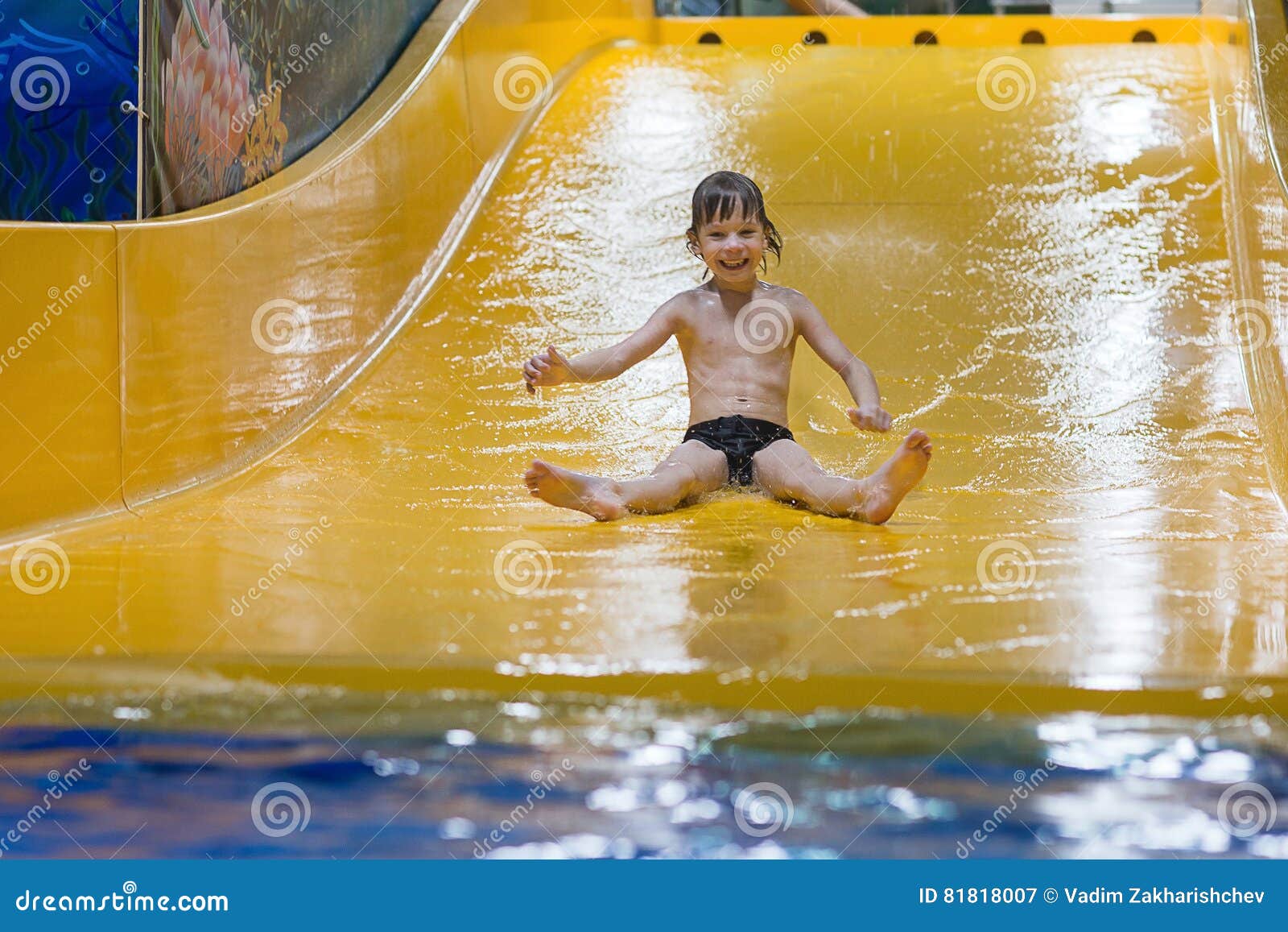 Boy enjoying water slide stock image. Image of pool, park - 81818007
