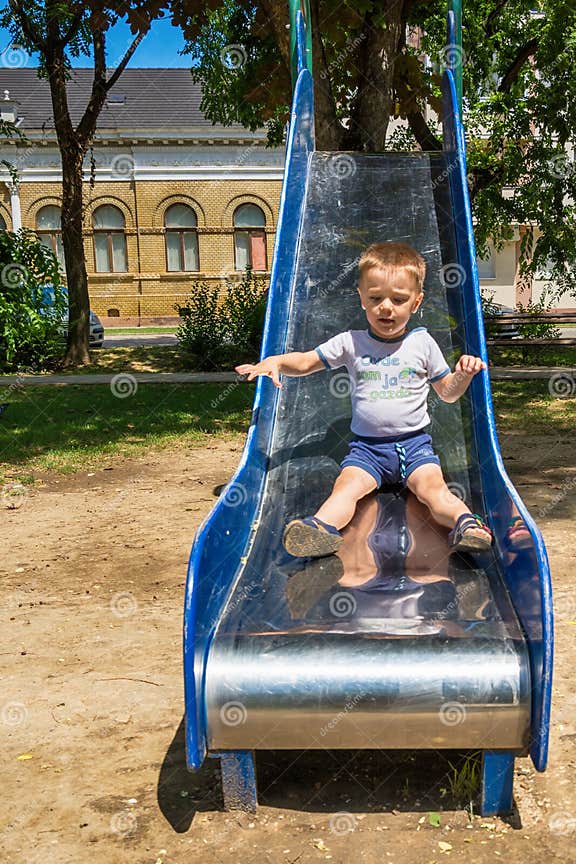 The Boy Enjoys Going Down the Slide Stock Image - Image of child ...