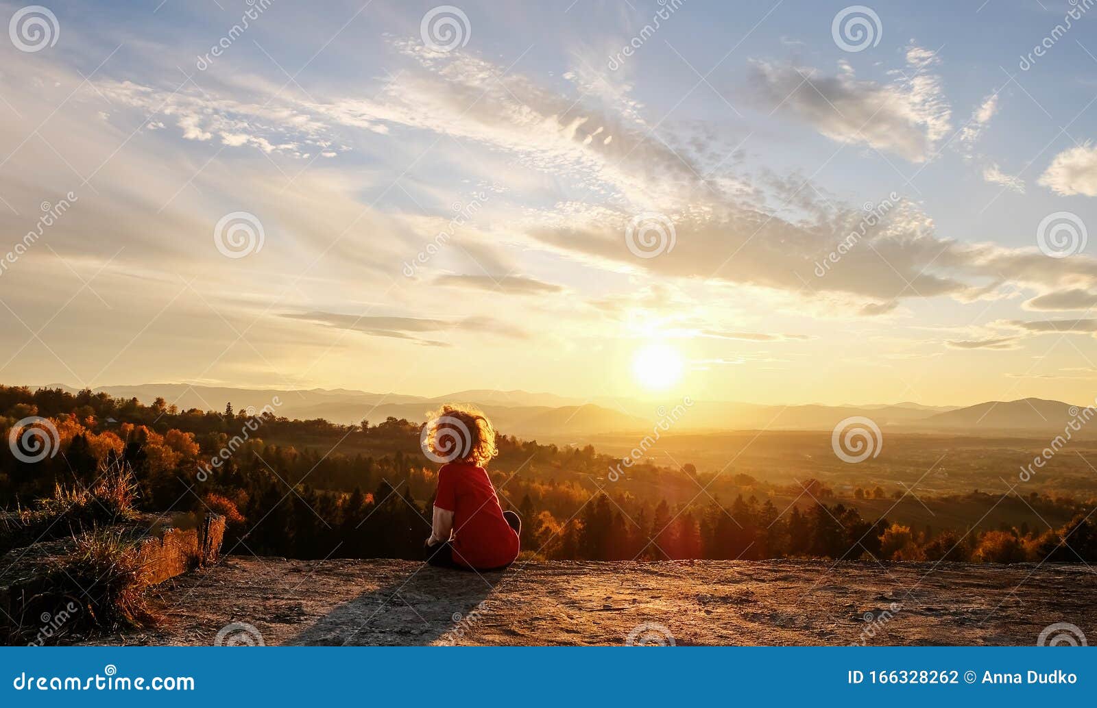 The Boy Enjoys the Sunset in the Mountains Stock Photo - Image of ...
