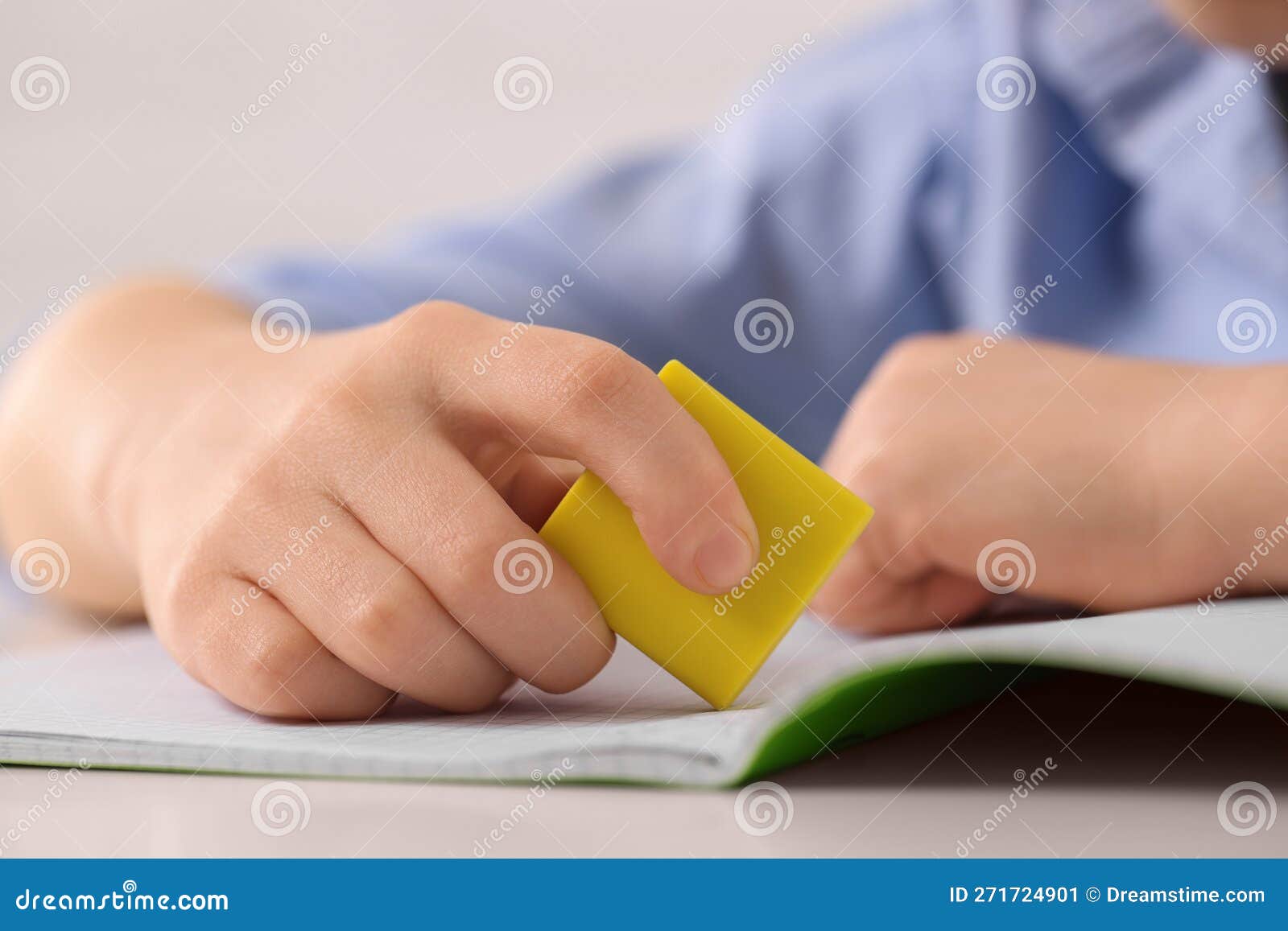 Boy Erasing Mistake in His Notebook at White Desk, Closeup Stock Image ...