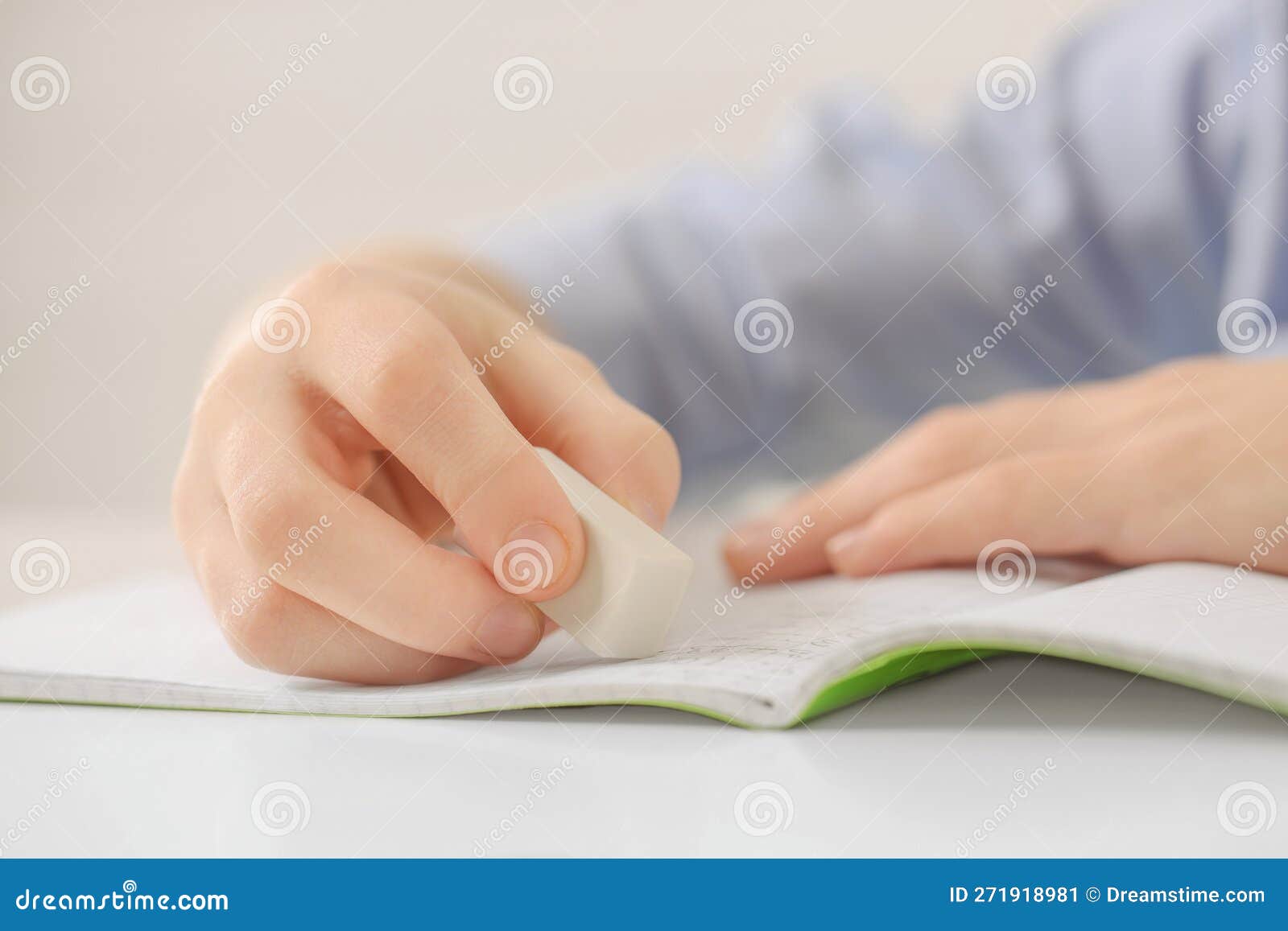 Boy Erasing Mistake in His Notebook at White Desk, Closeup Stock Image ...