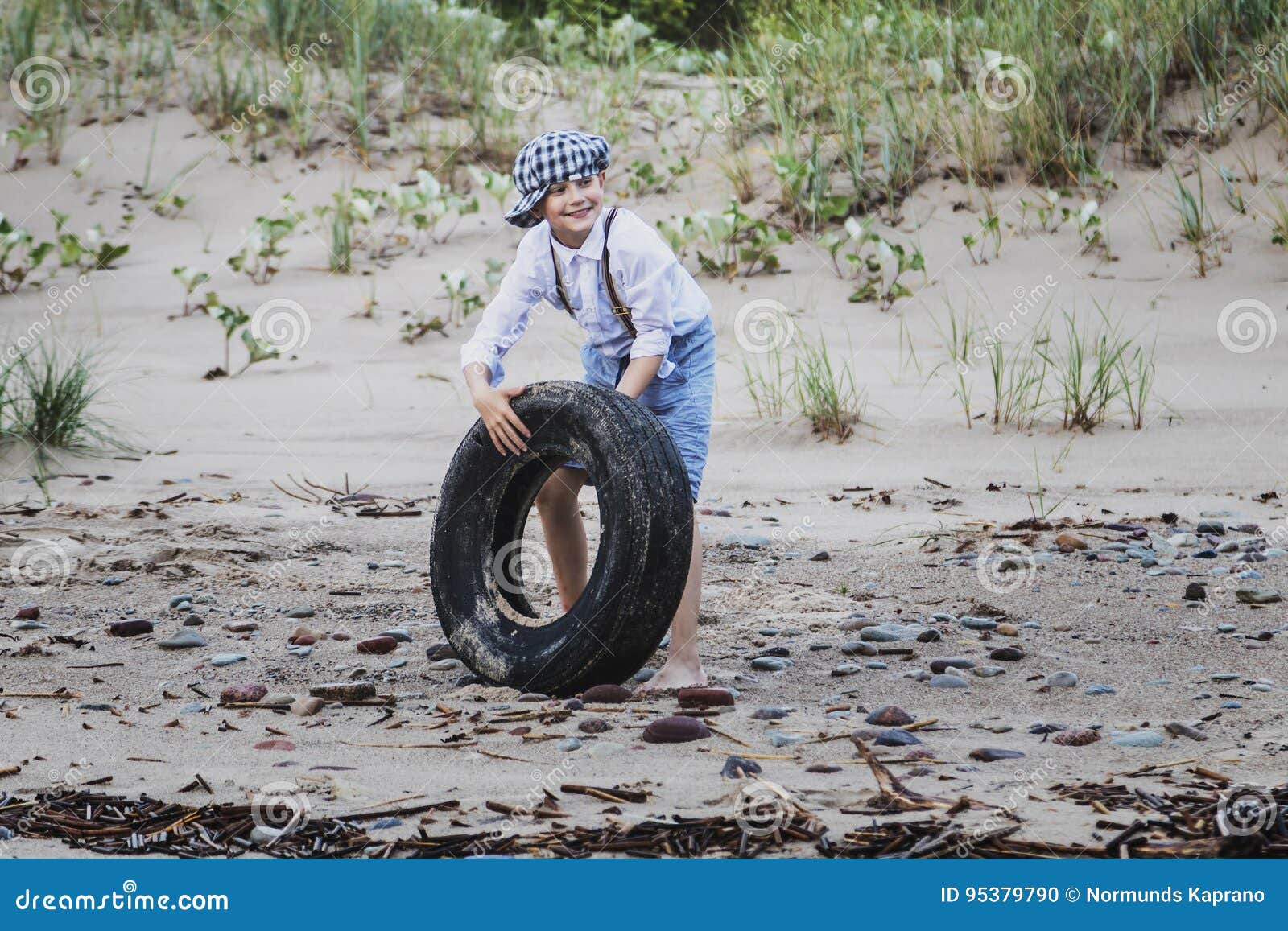 A Boy in the Evening at the Tyre Rolling Stock Photo - Image of male ...