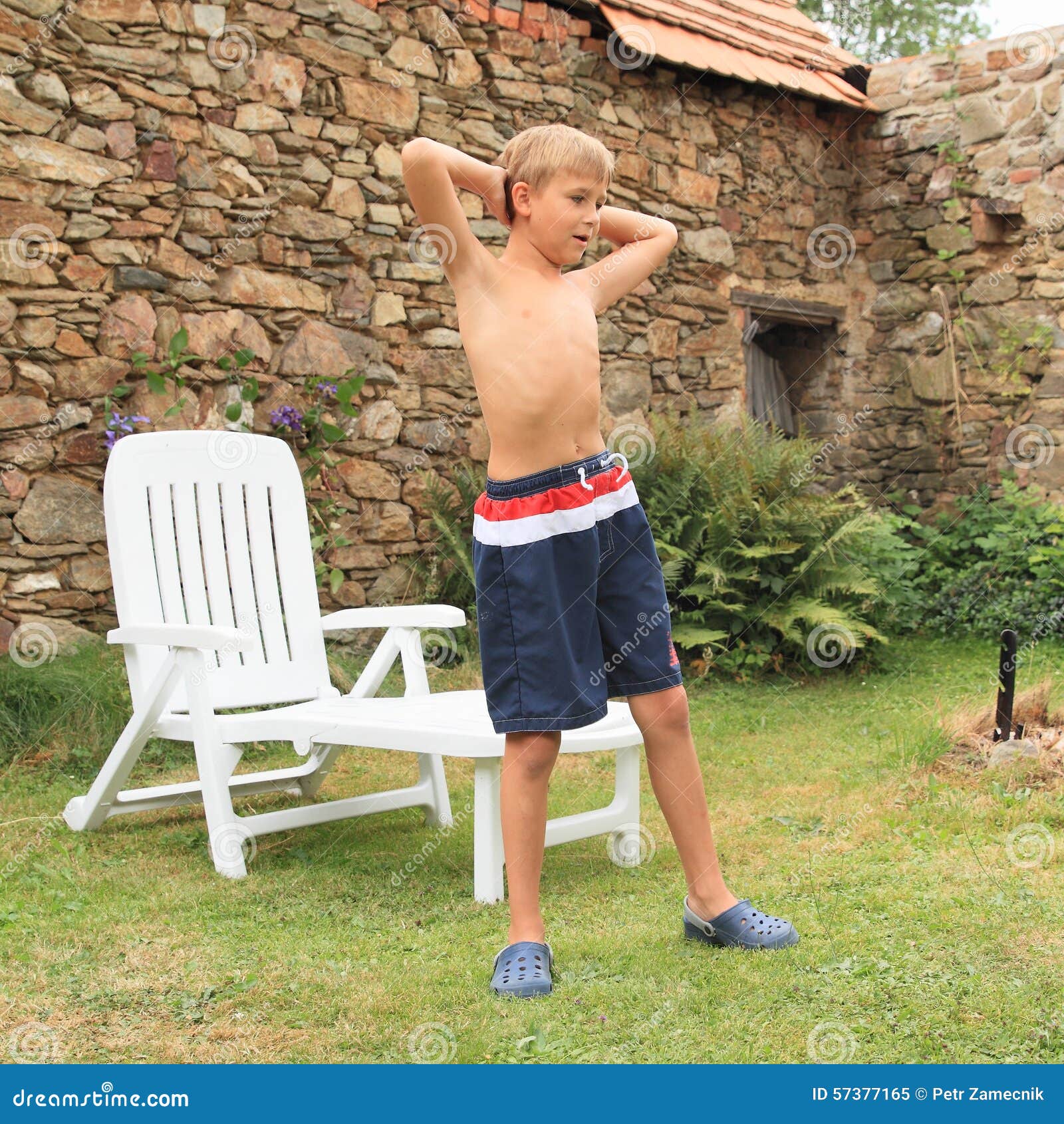 Boy Exercising in Front of Garden Lounger Stock Image - Image of shorts ...