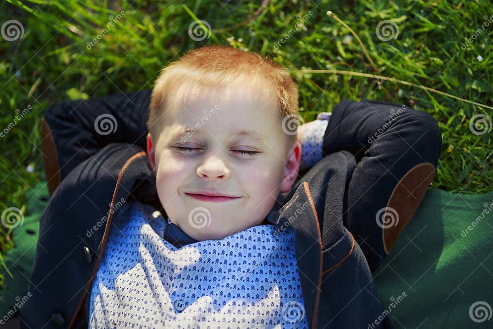 Boy with eyes closed stock image. Image of face, lawn - 71633213