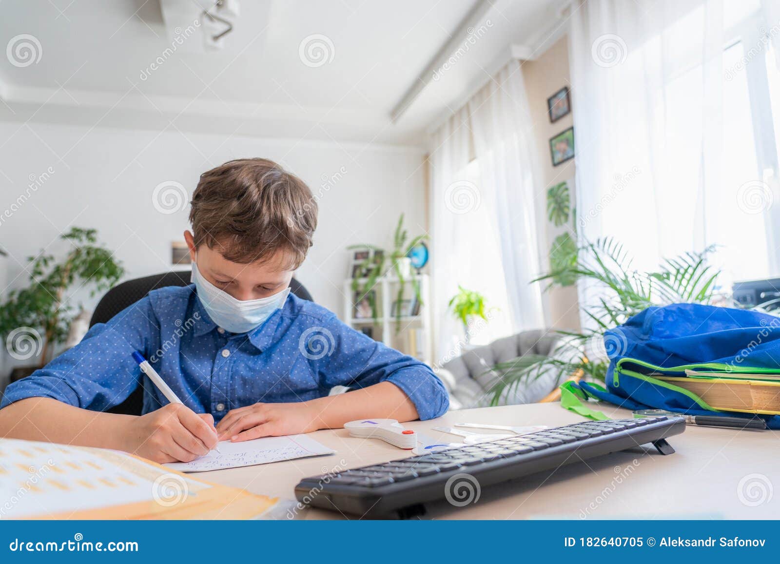 Boy in Face Mask Using Computer, Doing Homework during Coronavirus ...