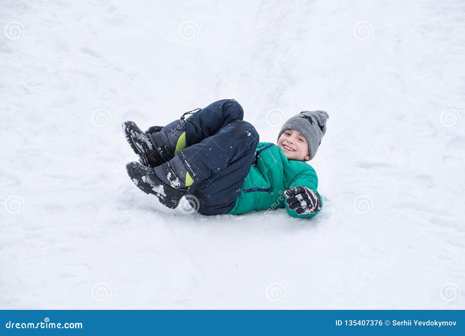 Boy Falls Rolling Down a Snowy Hill. Winter Games Stock Photo - Image ...