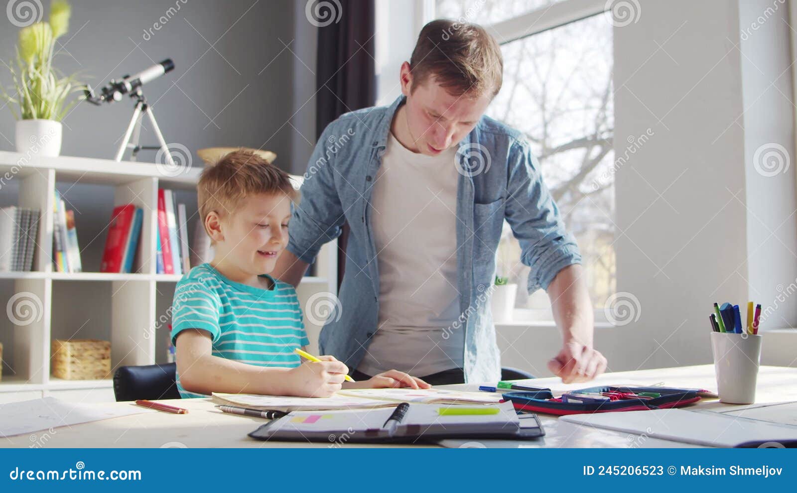 Boy and Father are Doing Homework at the Table. Cute Child is Learning ...