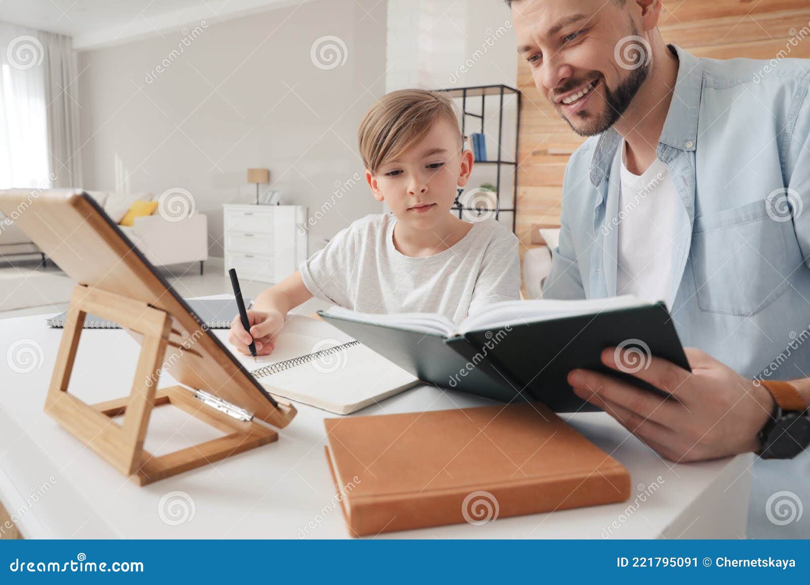 Boy with Father Doing Homework at Table Stock Image - Image of book ...
