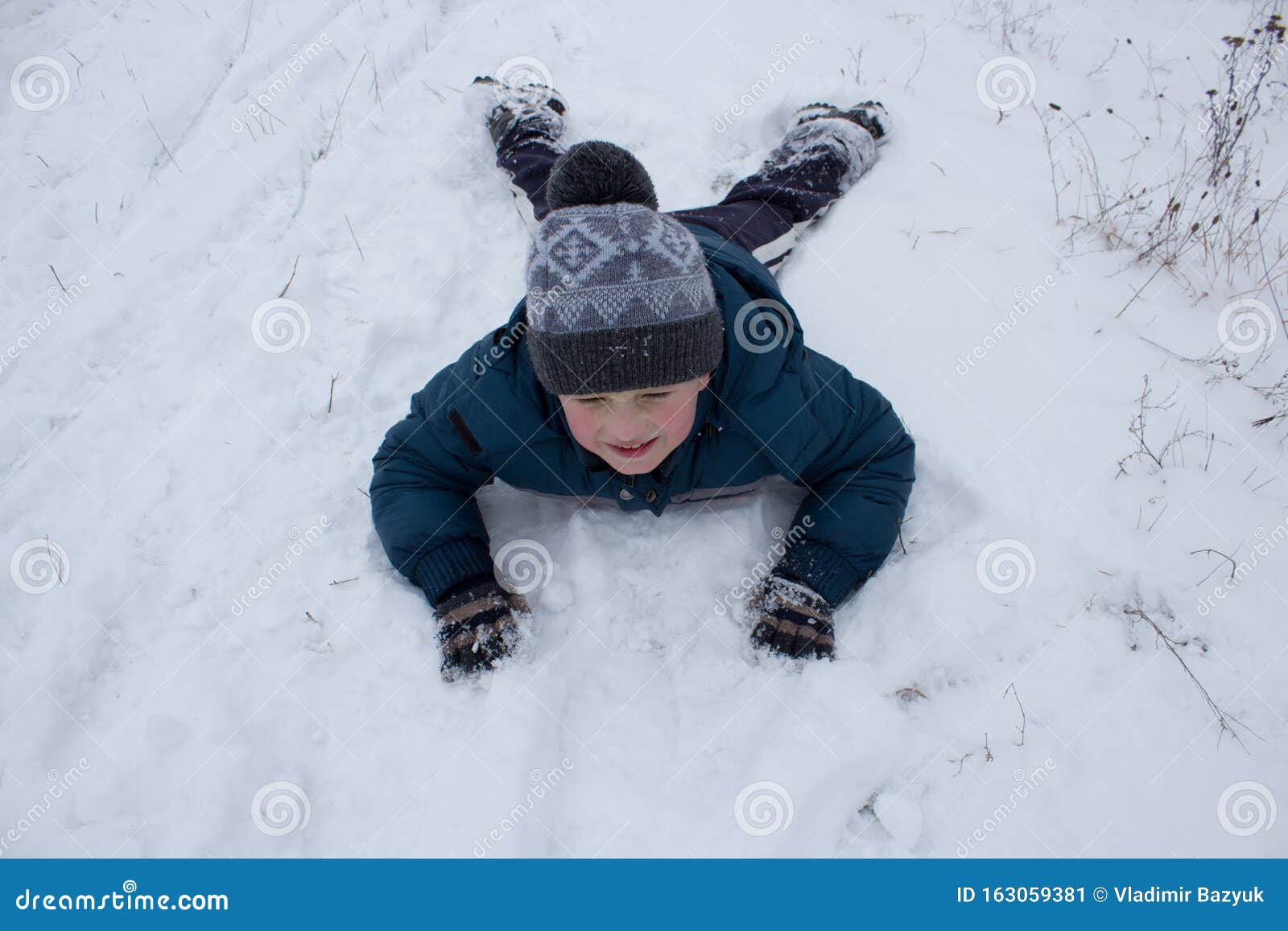 Boy Lying on the Snow on His Stomach,the Boy Fell Forward into the Snow ...