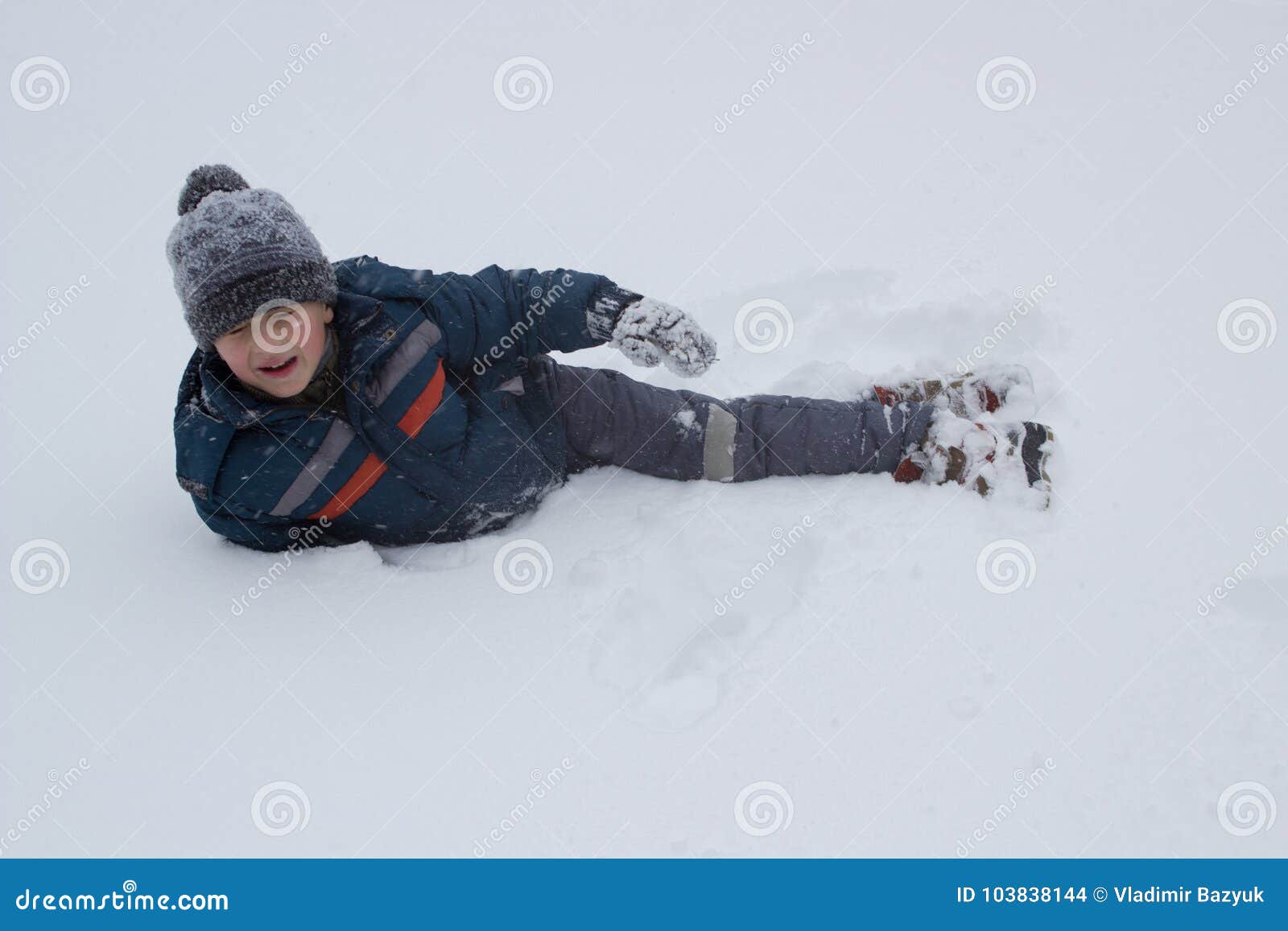 Boy fell to the snow stock photo. Image of activity - 103838144