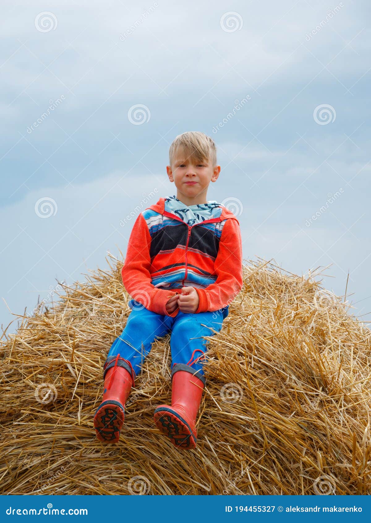 Boy in the Field Playing on a Stack of Straw Stock Image - Image of ...