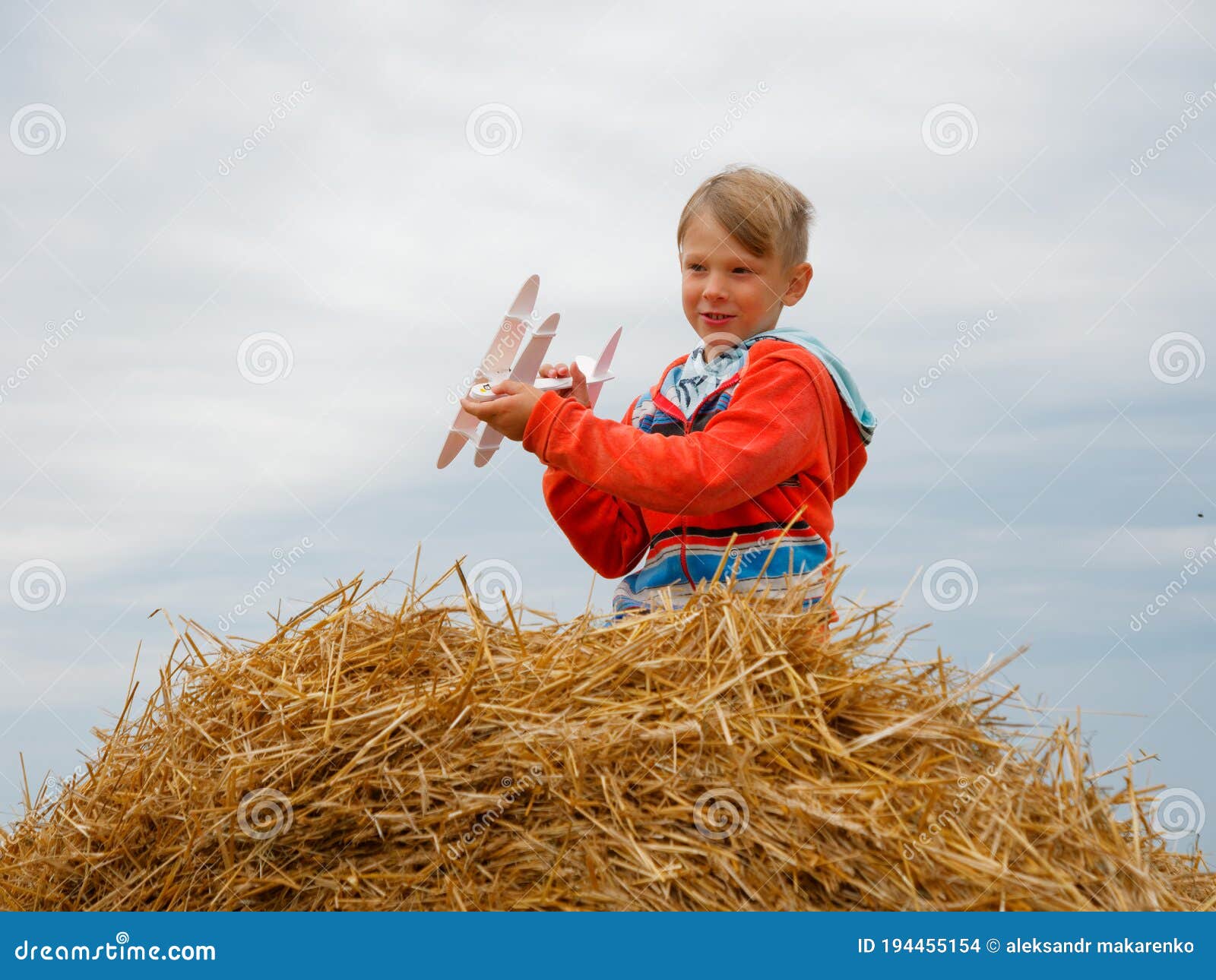 Boy in the Field Playing with a Toy Airplane Stock Photo - Image of ...
