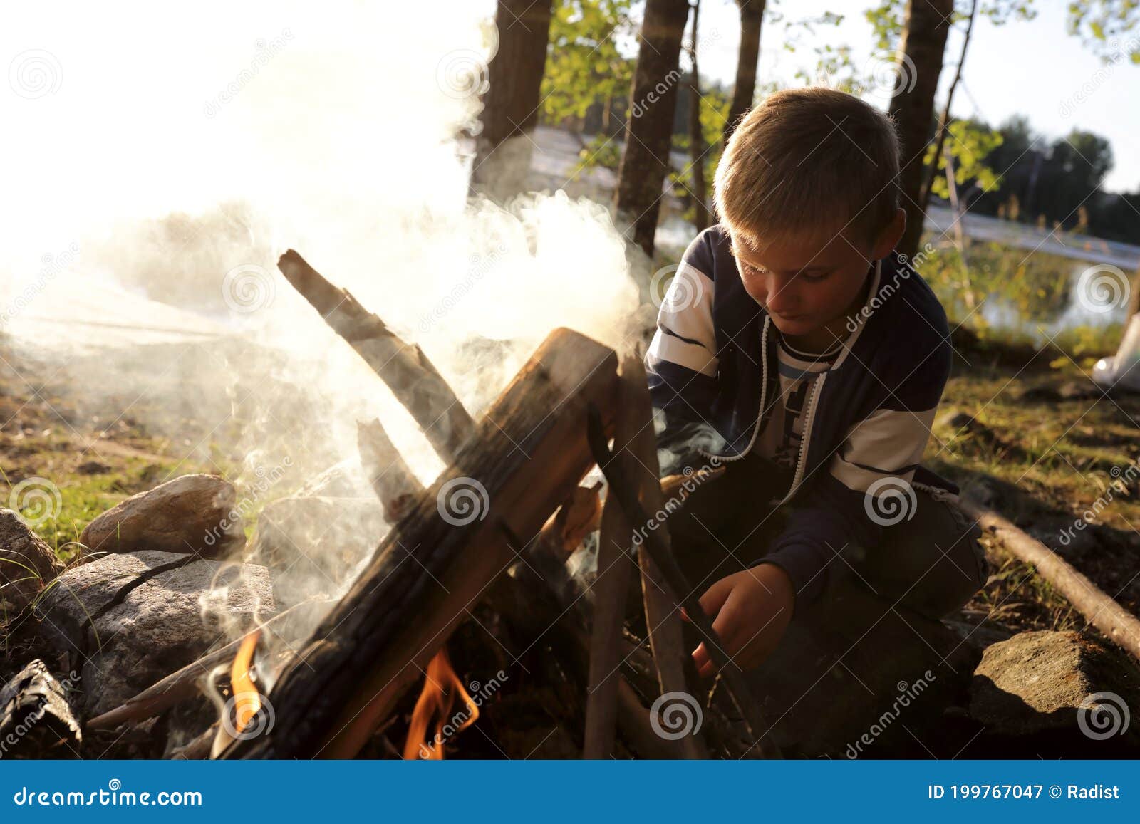 Boy by Fire in Forest in Evening Stock Image - Image of forest, outdoor ...