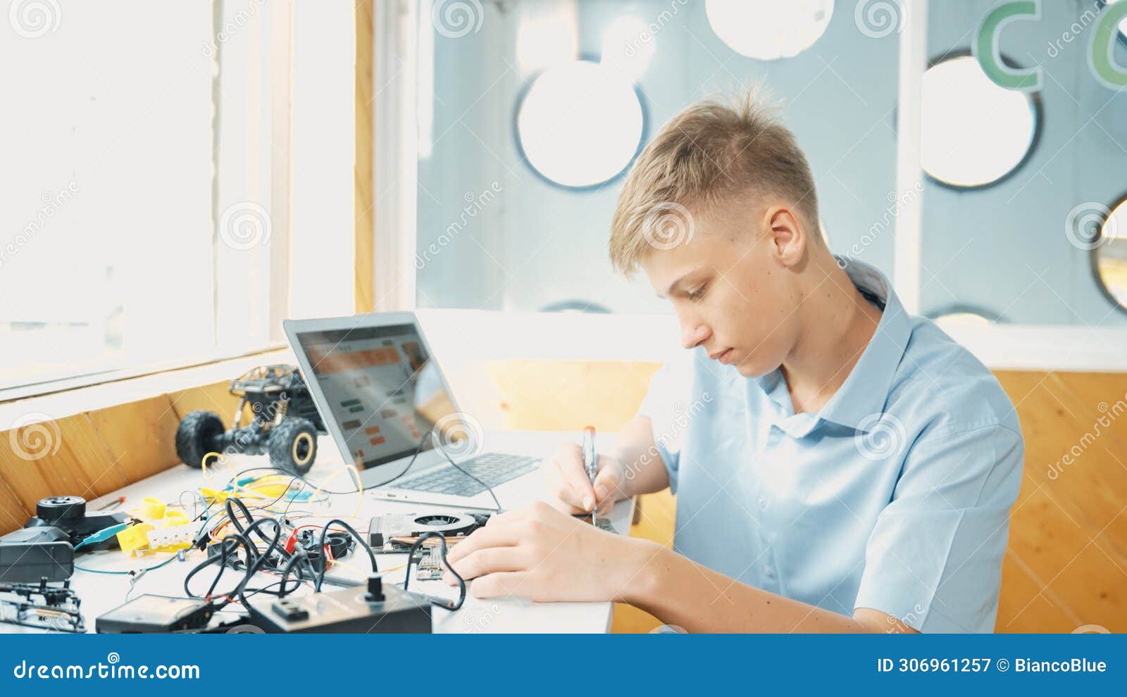 Boy Fixing Main Board while Study Construction by Using Laptop ...
