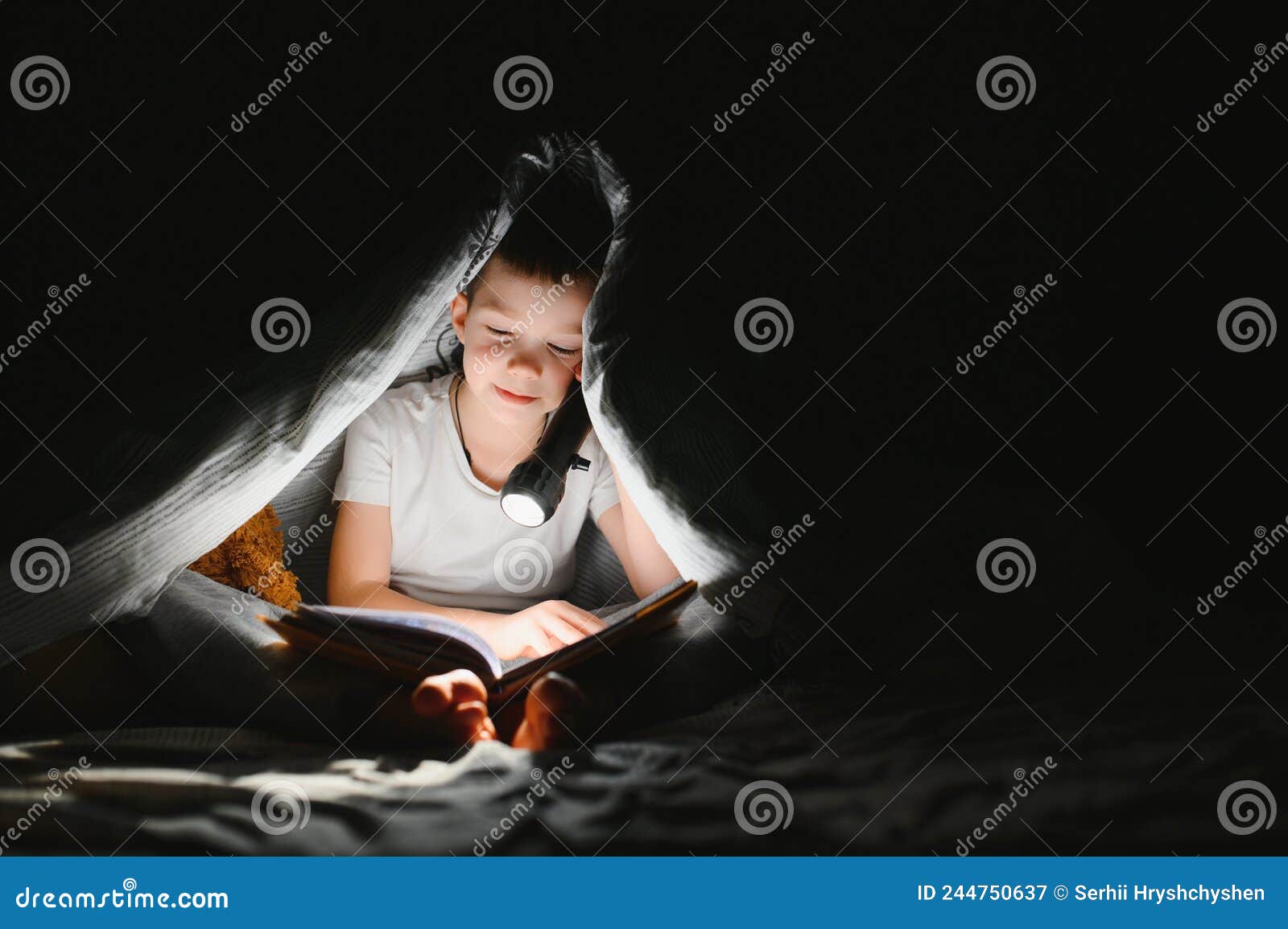 Boy with Flashlight Reading Book Under Blanket at Home. Stock Image ...