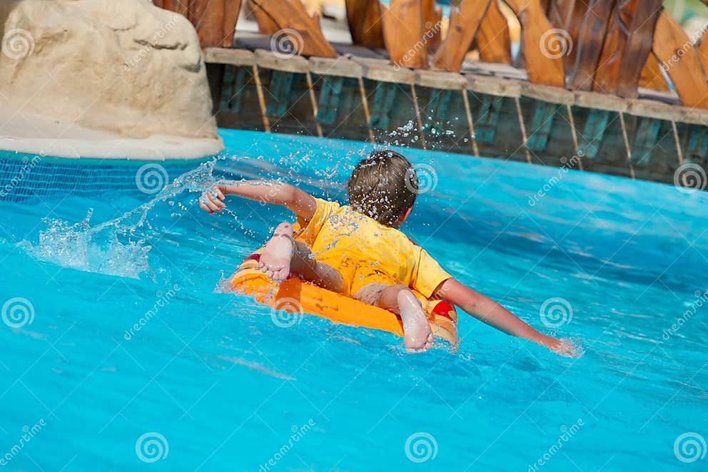 Boy on float in pool stock photo. Image of swimming, summery - 20340904
