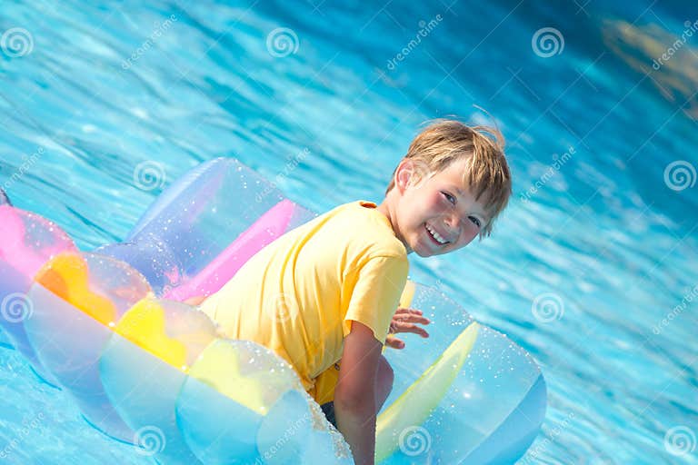 Boy on float swimming pool stock photo. Image of swimming - 20341480
