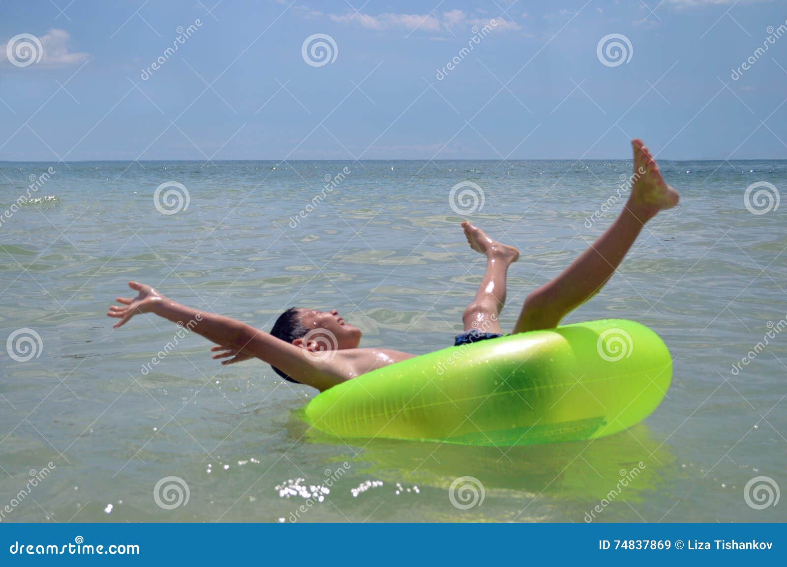 Boy floating in green ring stock image. Image of summer - 74837869