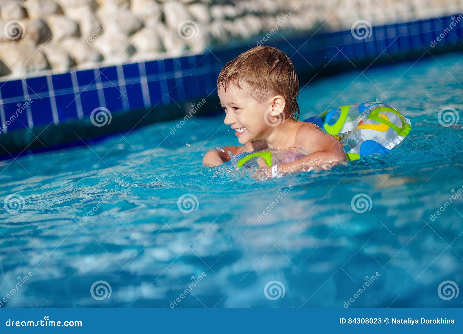 Boy Floating on an Inflatable Circle in the Pool. Swimming into Resort ...
