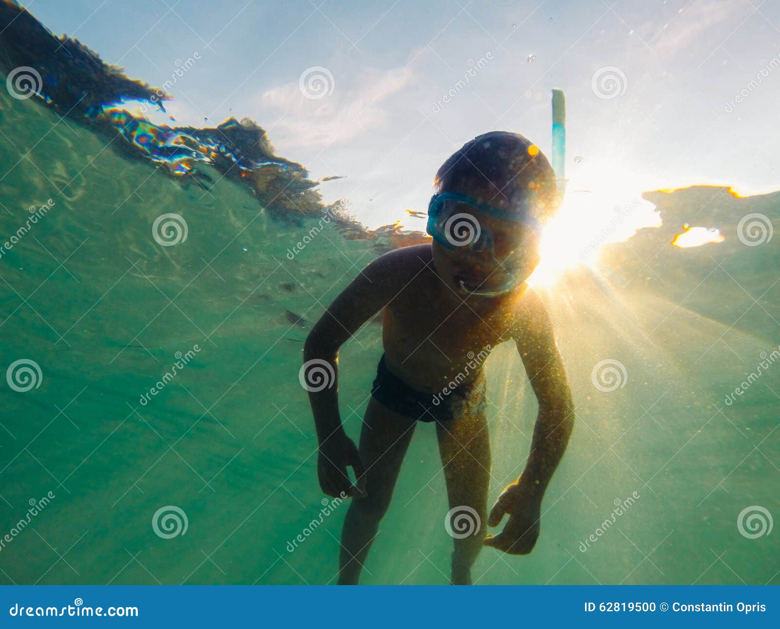 Boy floating in underwater stock photo. Image of sunlight - 62819500