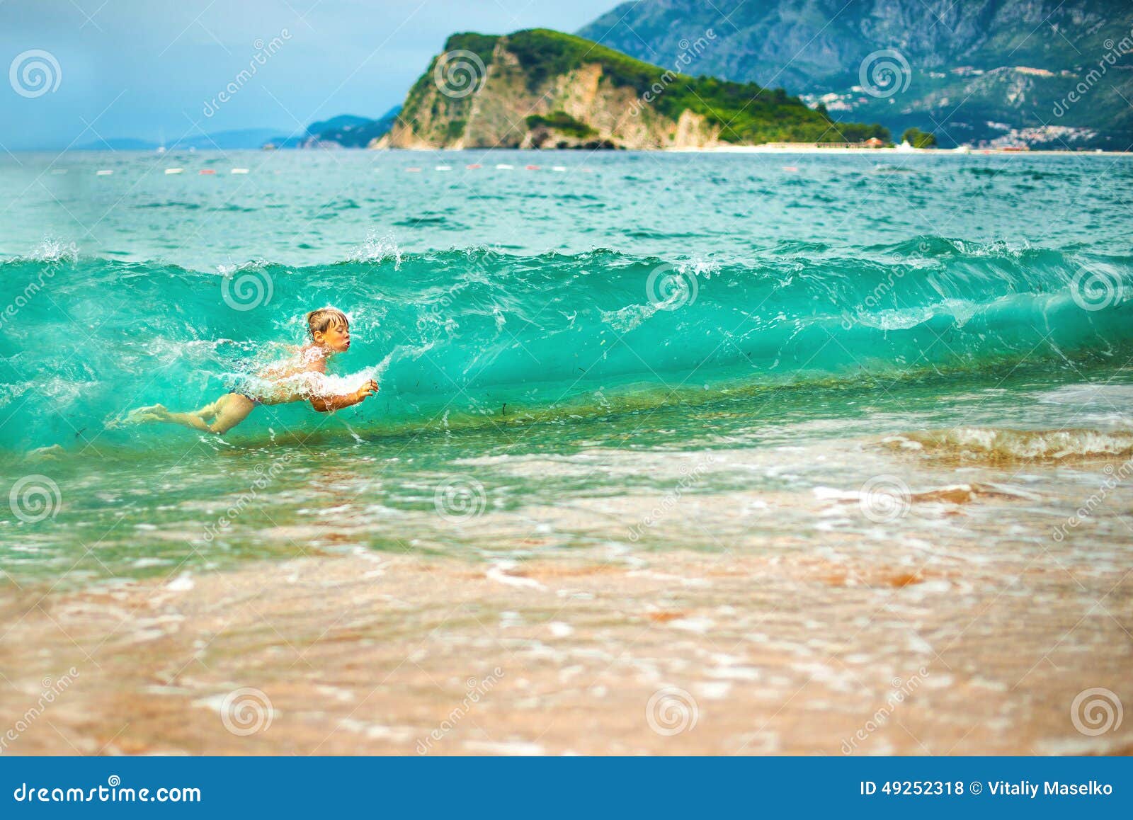 Boy floating on the waves stock photo. Image of play - 49252318