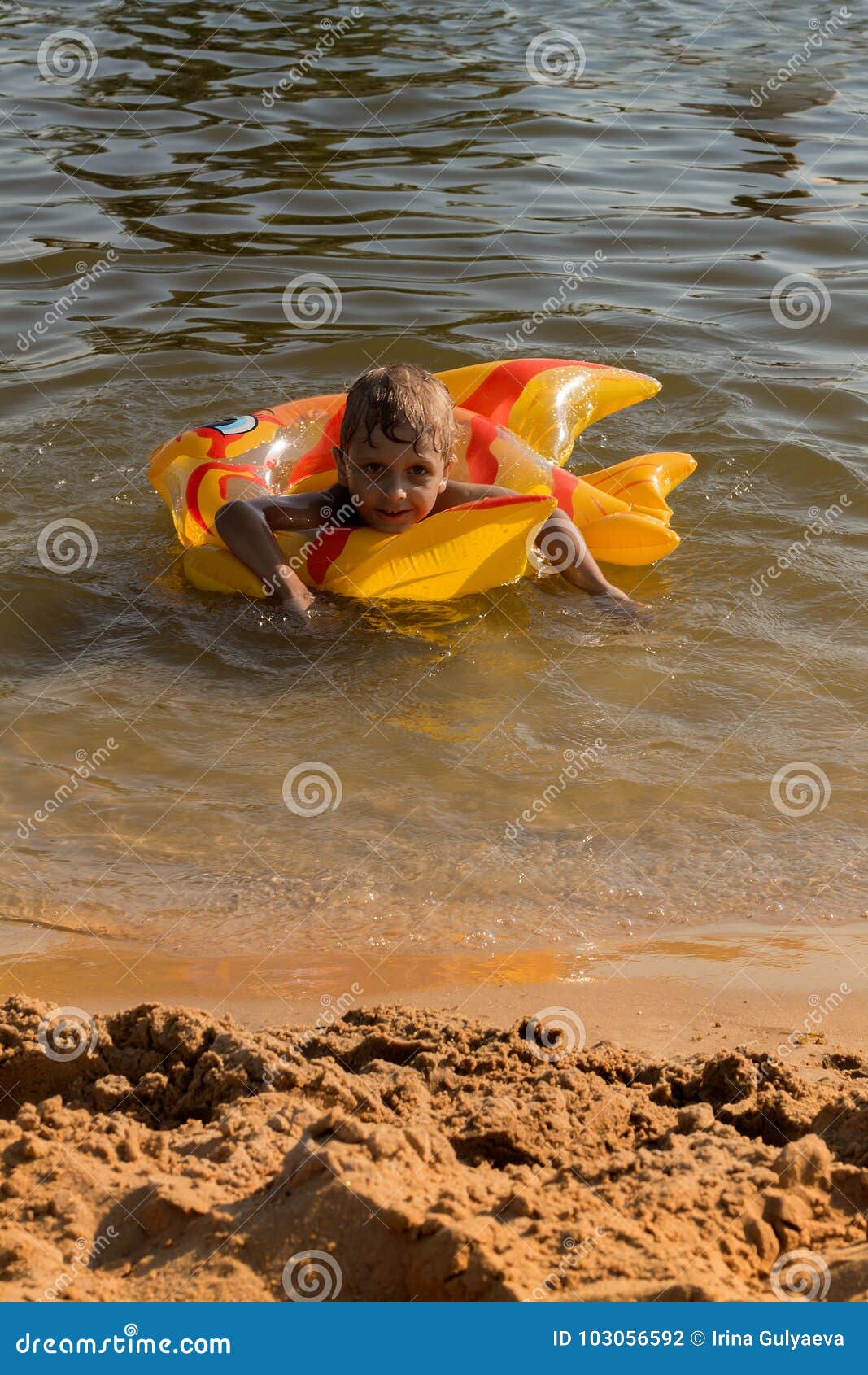 A Boy Floats on an Inflatable Circle Stock Photo - Image of beach, ring ...