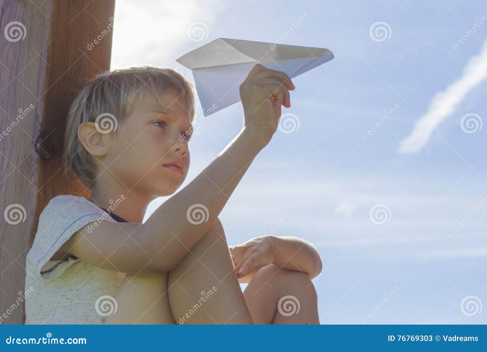 Boy Flying a Paper Plane Against Blue Sky. Summer Day. Low Angle View ...