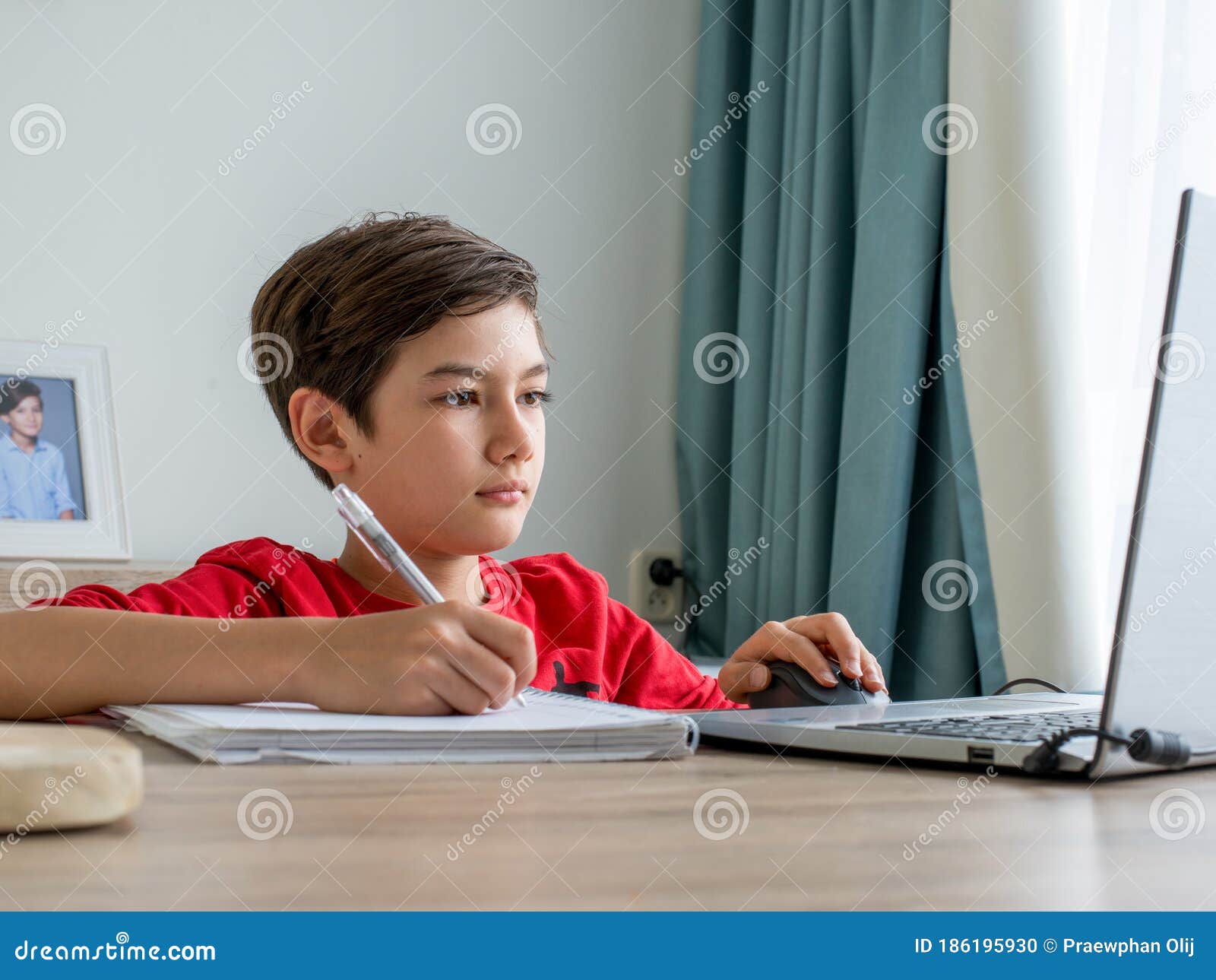 A Boy Focusing on Study, Writing on Paper. Homeschooling Concept Stock ...