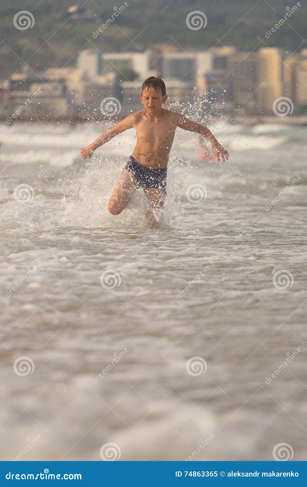 Boy Frolics in the Sea with Splashes and Waves Stock Image - Image of ...