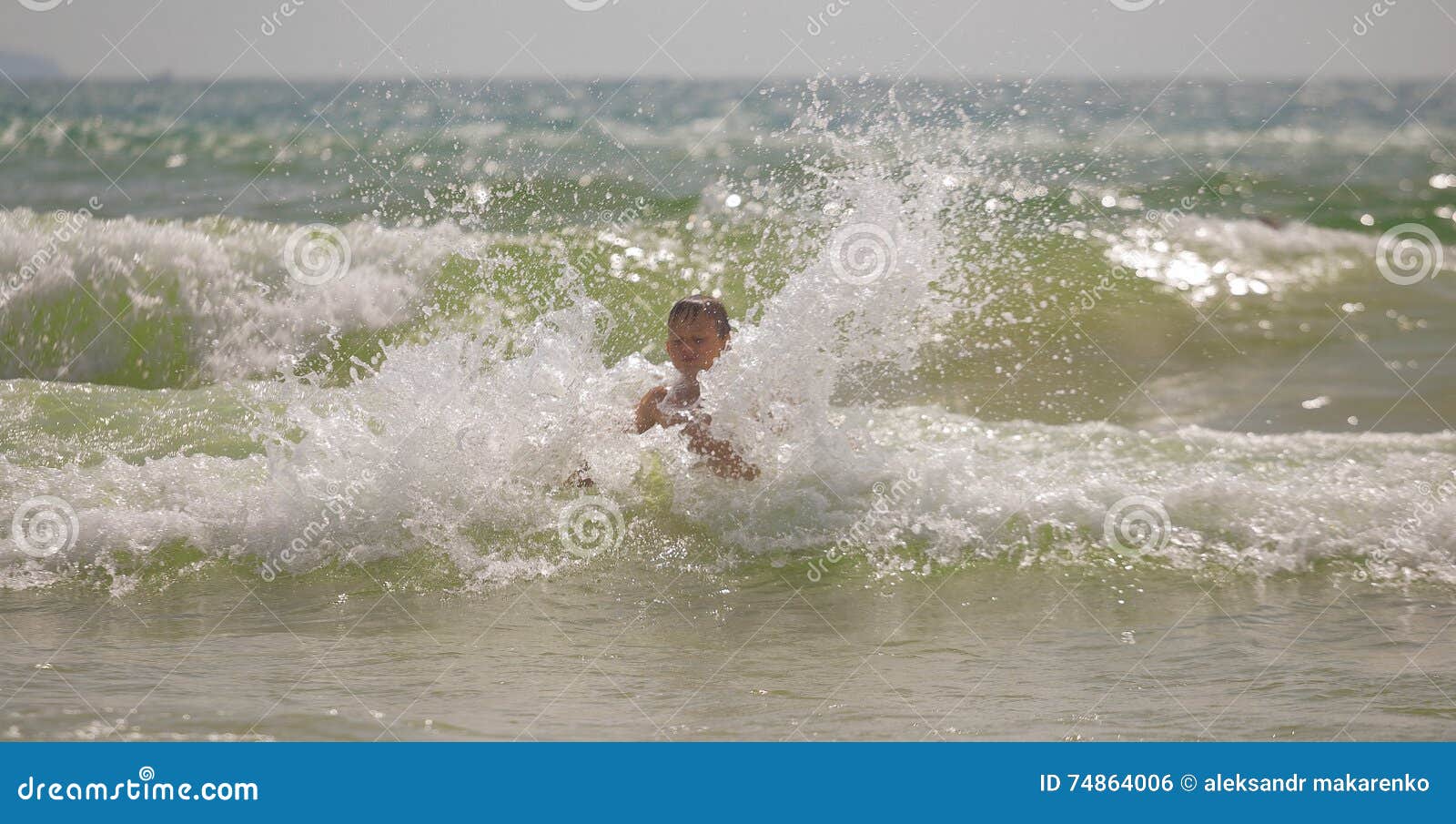 Boy Frolics in the Sea with Splashes and Waves Stock Photo - Image of ...